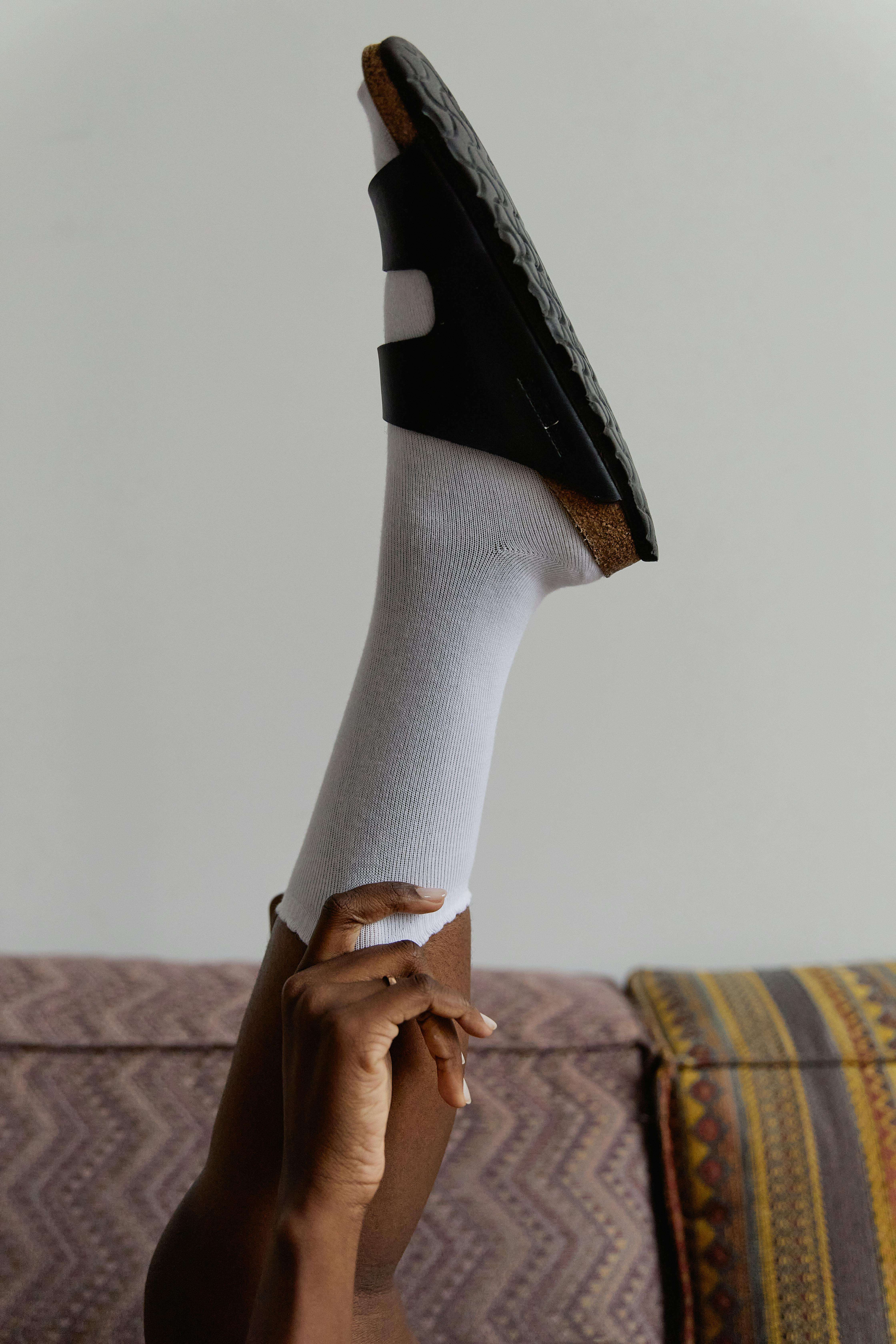 Hand over Leg with Sock and Shoe · Free Stock Photo