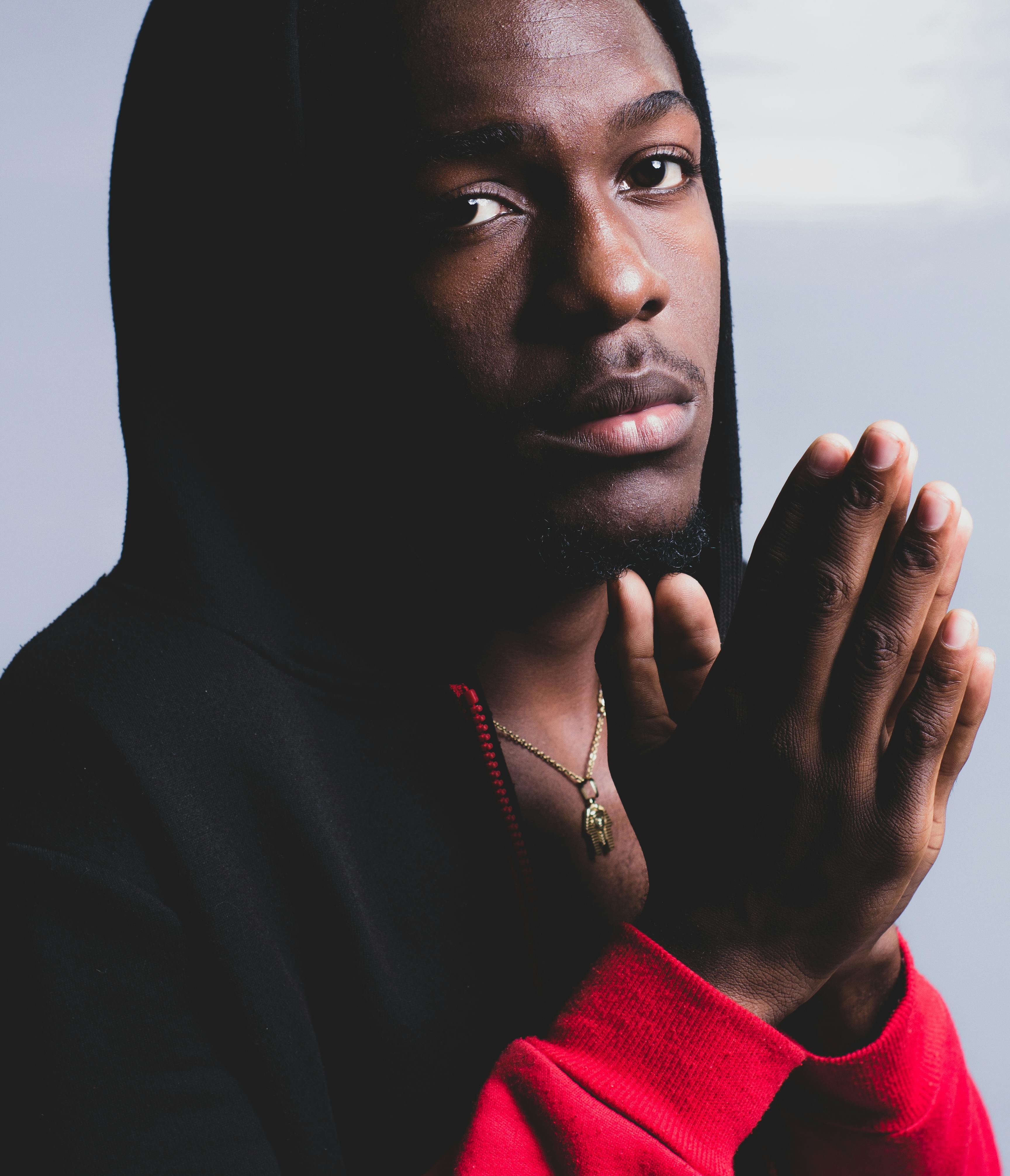 Man in Black Hoodie Jacket with His Hands Together · Free Stock Photo