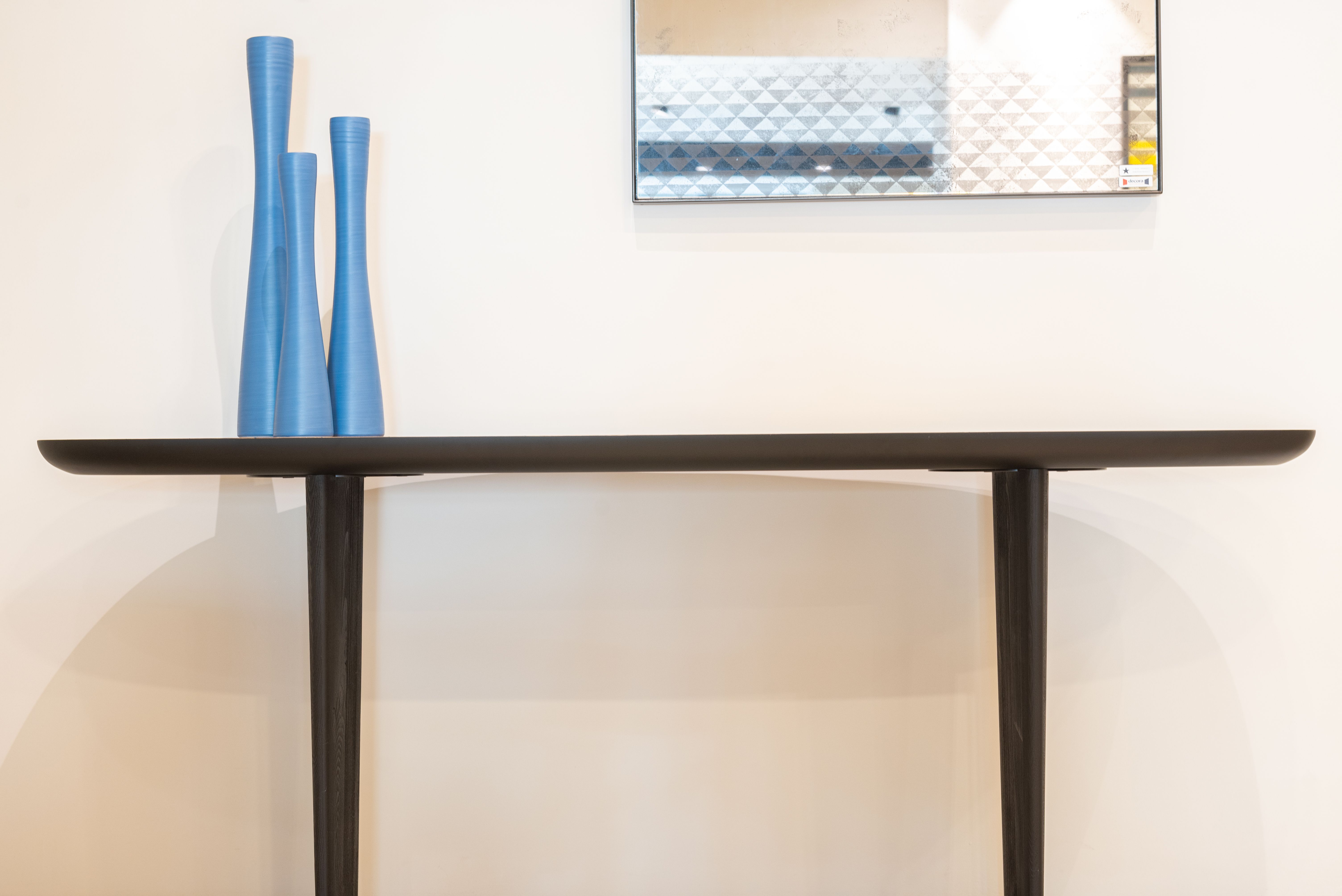 Wooden table with vases near white wall with abstract picture · Free ...