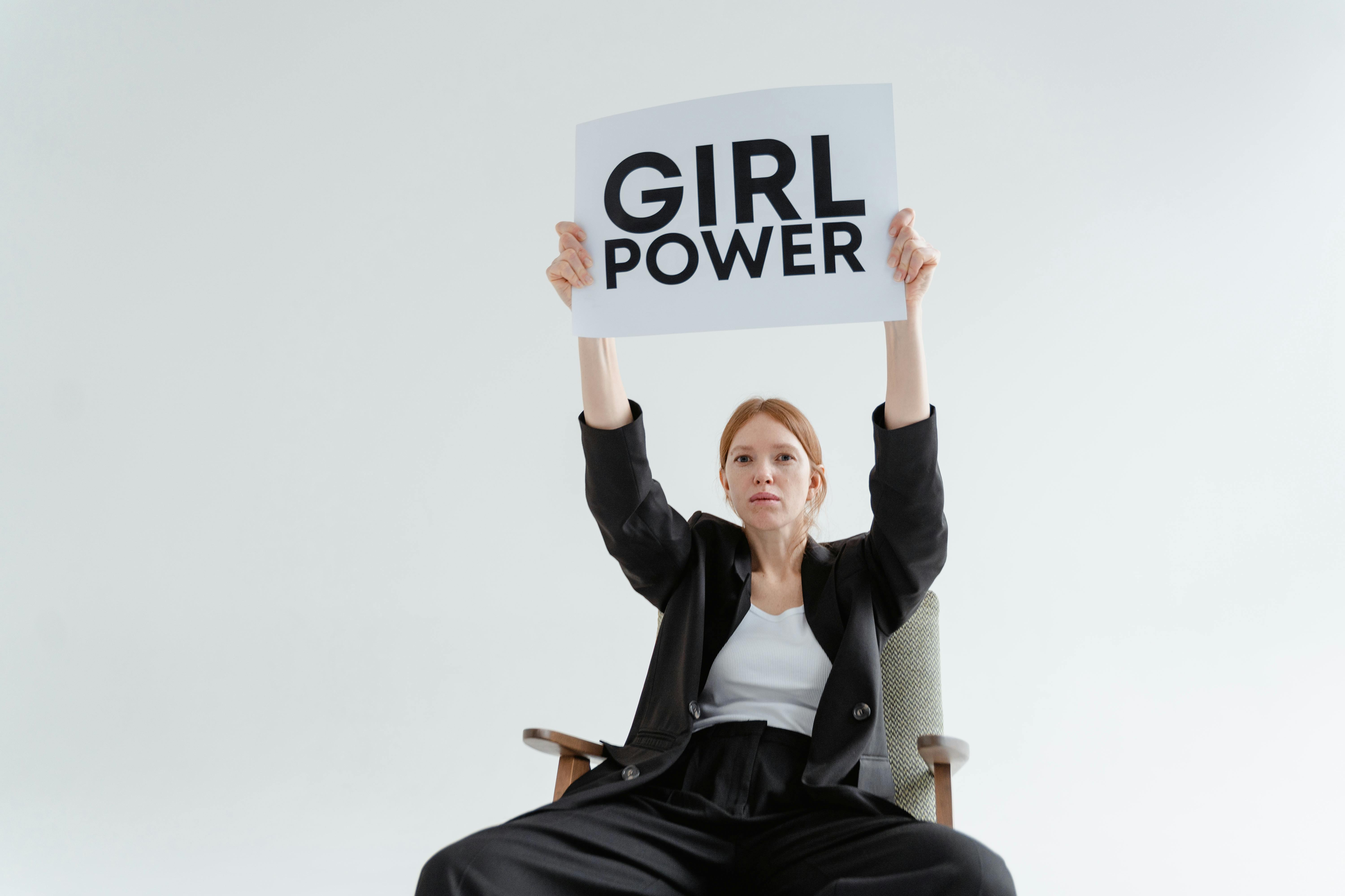Woman in Black Blazer and Pants Holding a Girl Power Postcard · Free ...