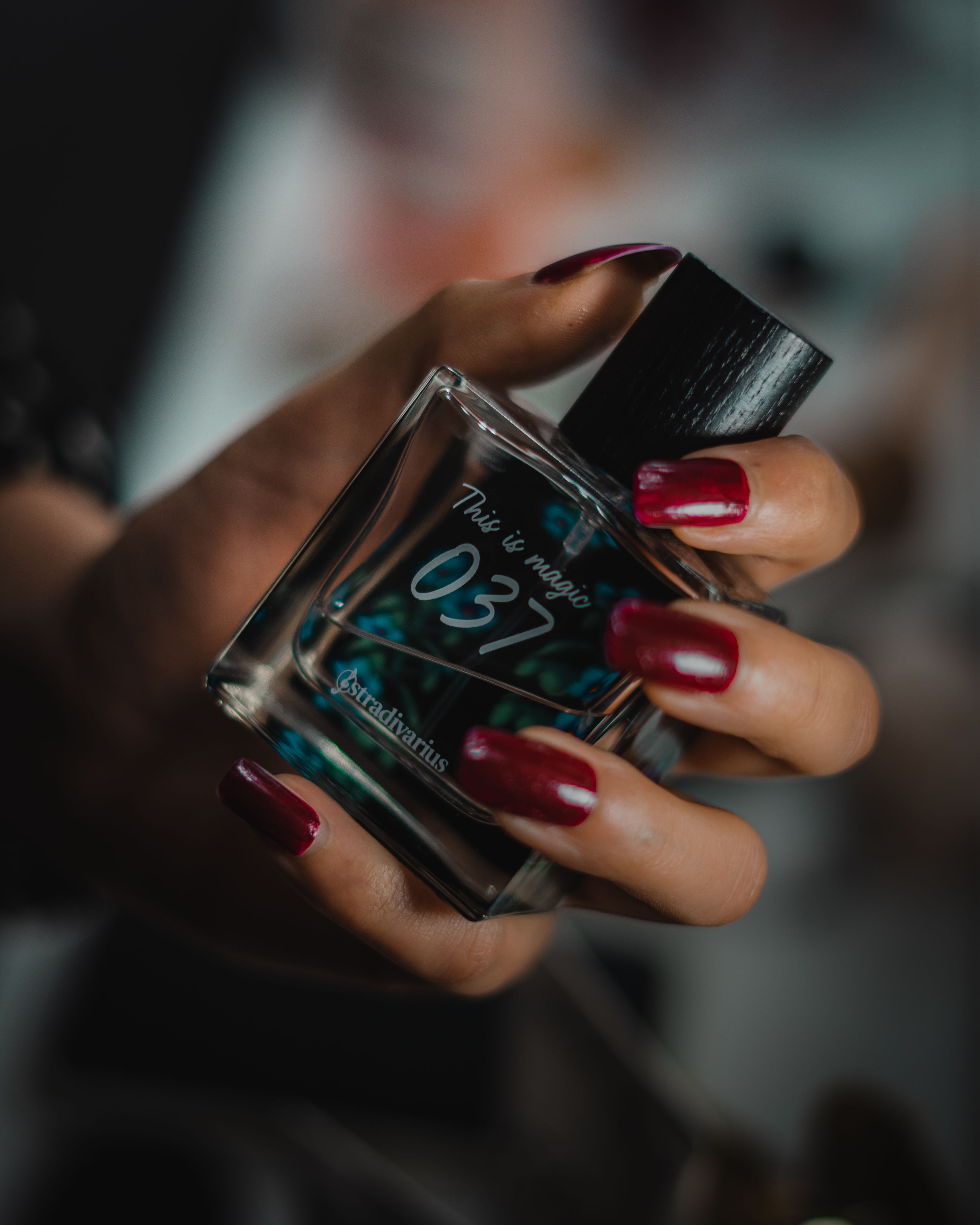A Person's Hand Holding a Perfume Bottle · Free Stock Photo