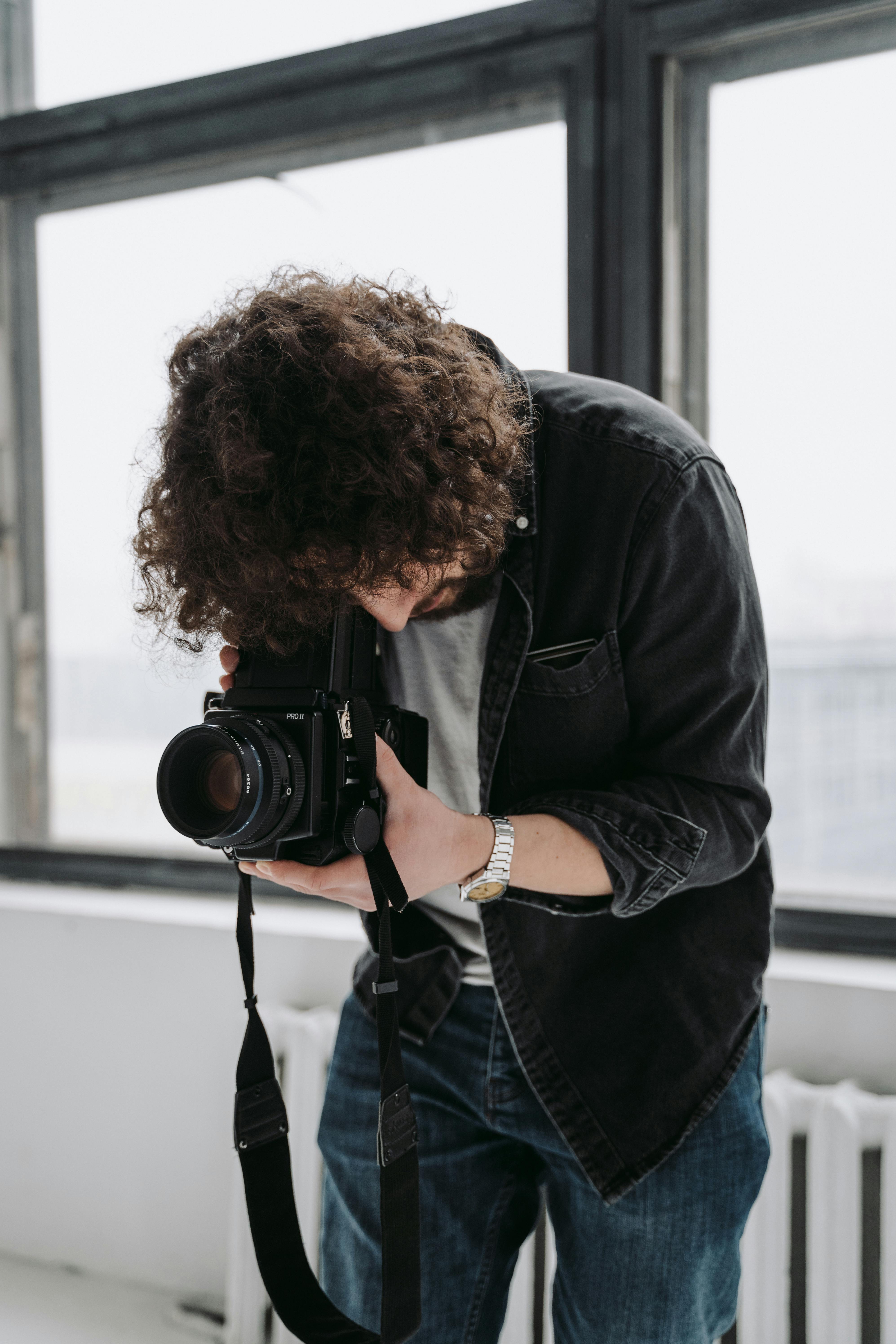 A Photographer Using an Analog Camera · Free Stock Photo
