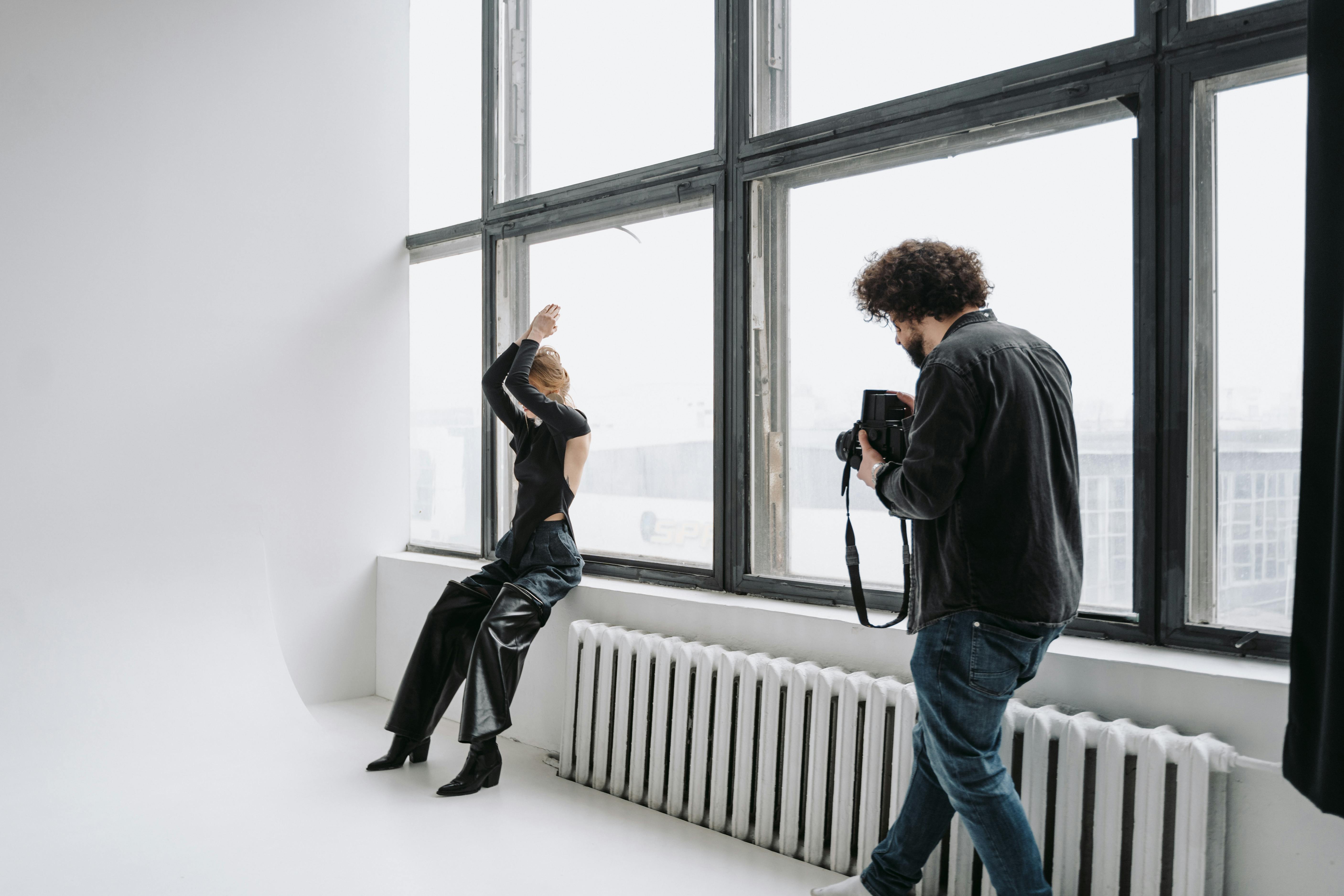 A Model and a Photographer Photoshoot Inside a Studio · Free Stock Photo