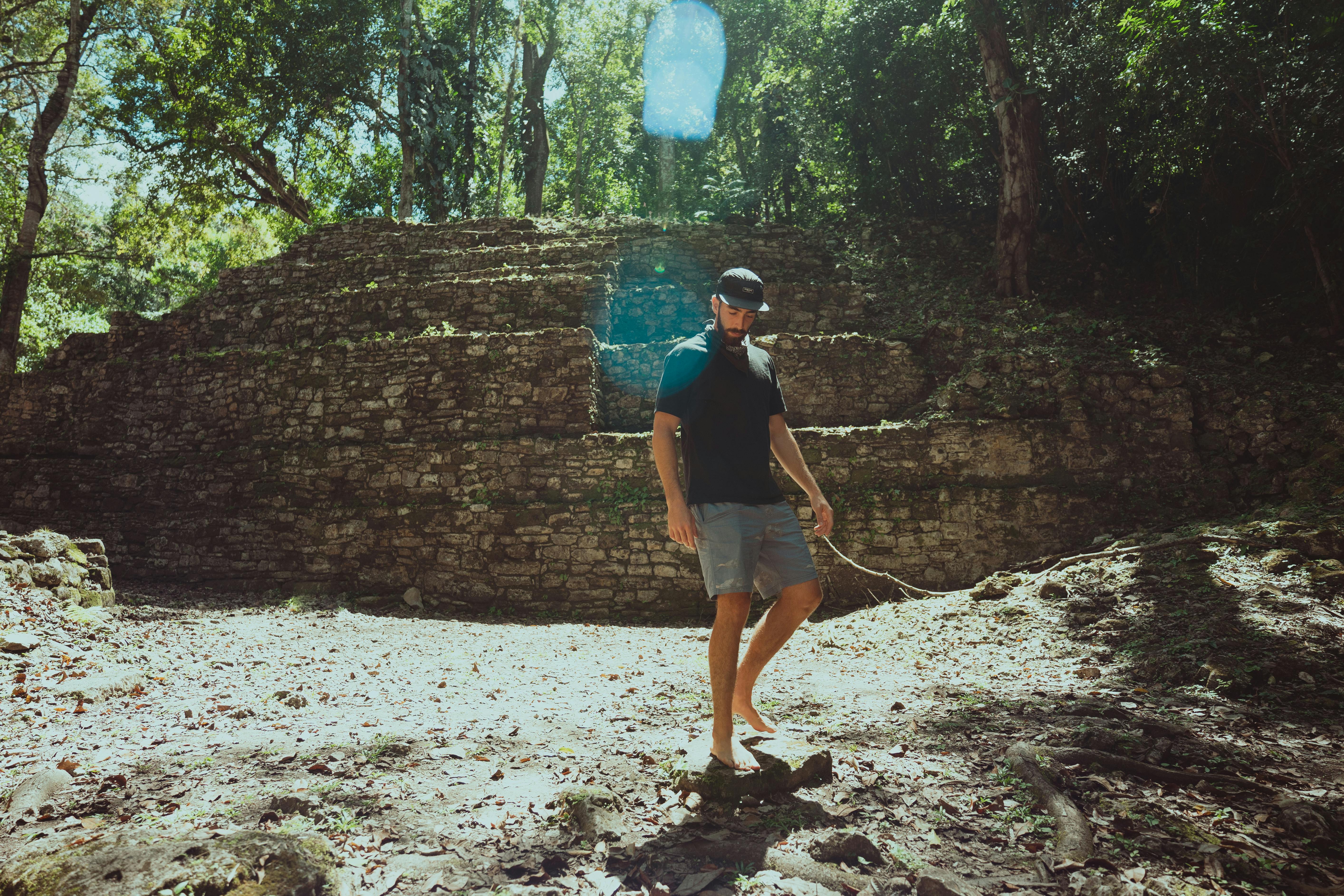 A Man Stepping on a Rock Barefooted · Free Stock Photo