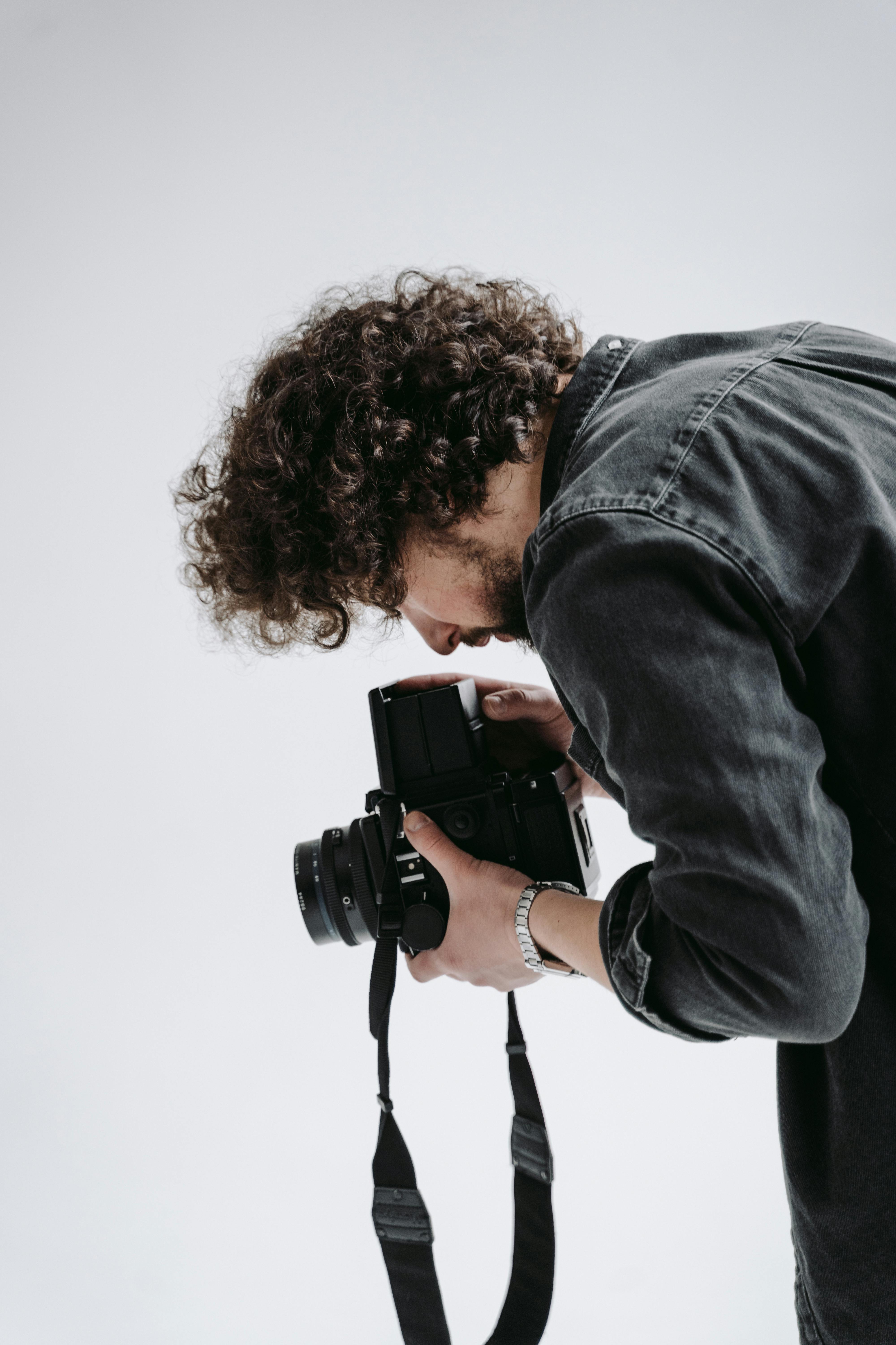 Person Using Camera Photo on Brown Surface · Free Stock Photo