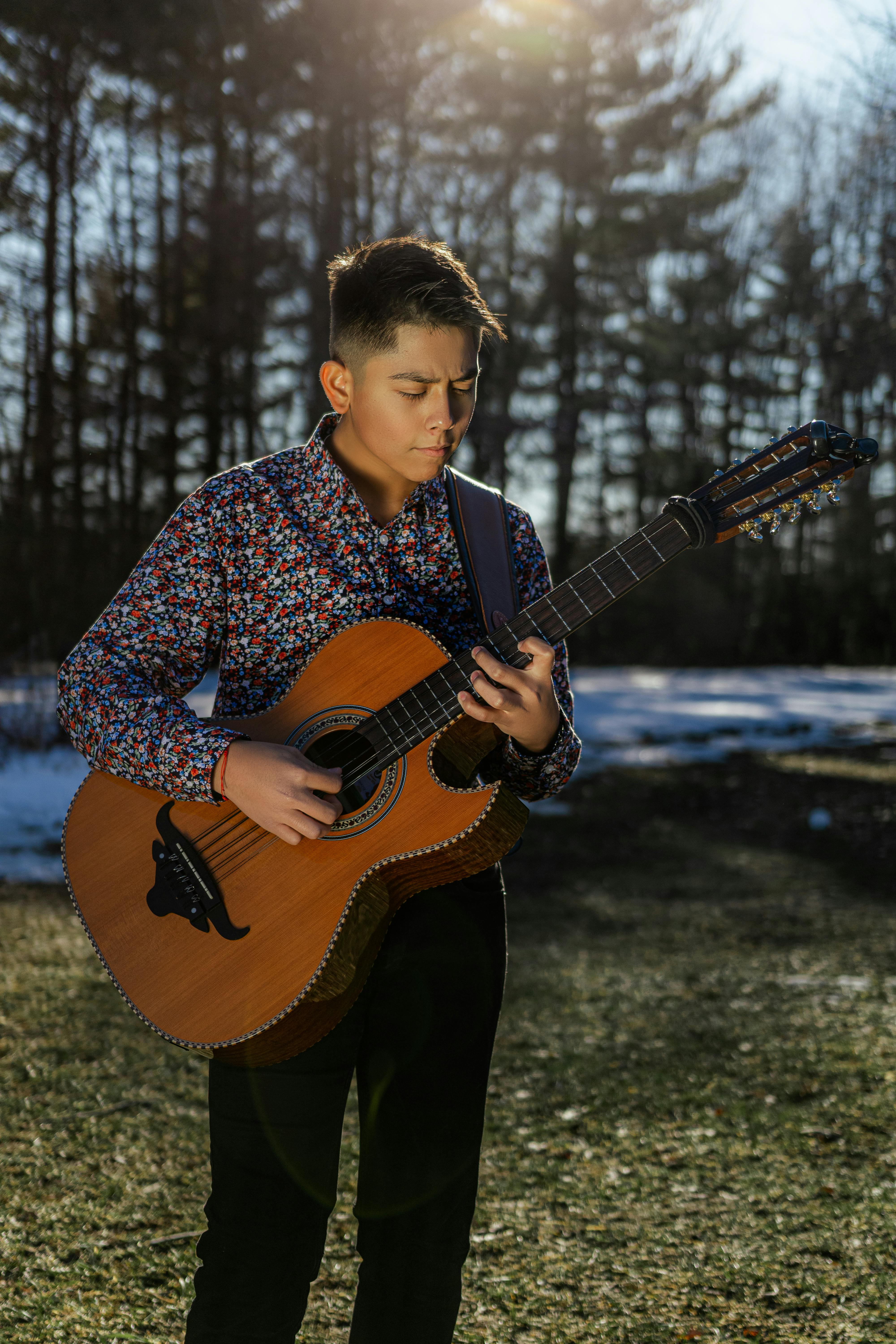 Photo of a Man Playing a Guitar · Free Stock Photo