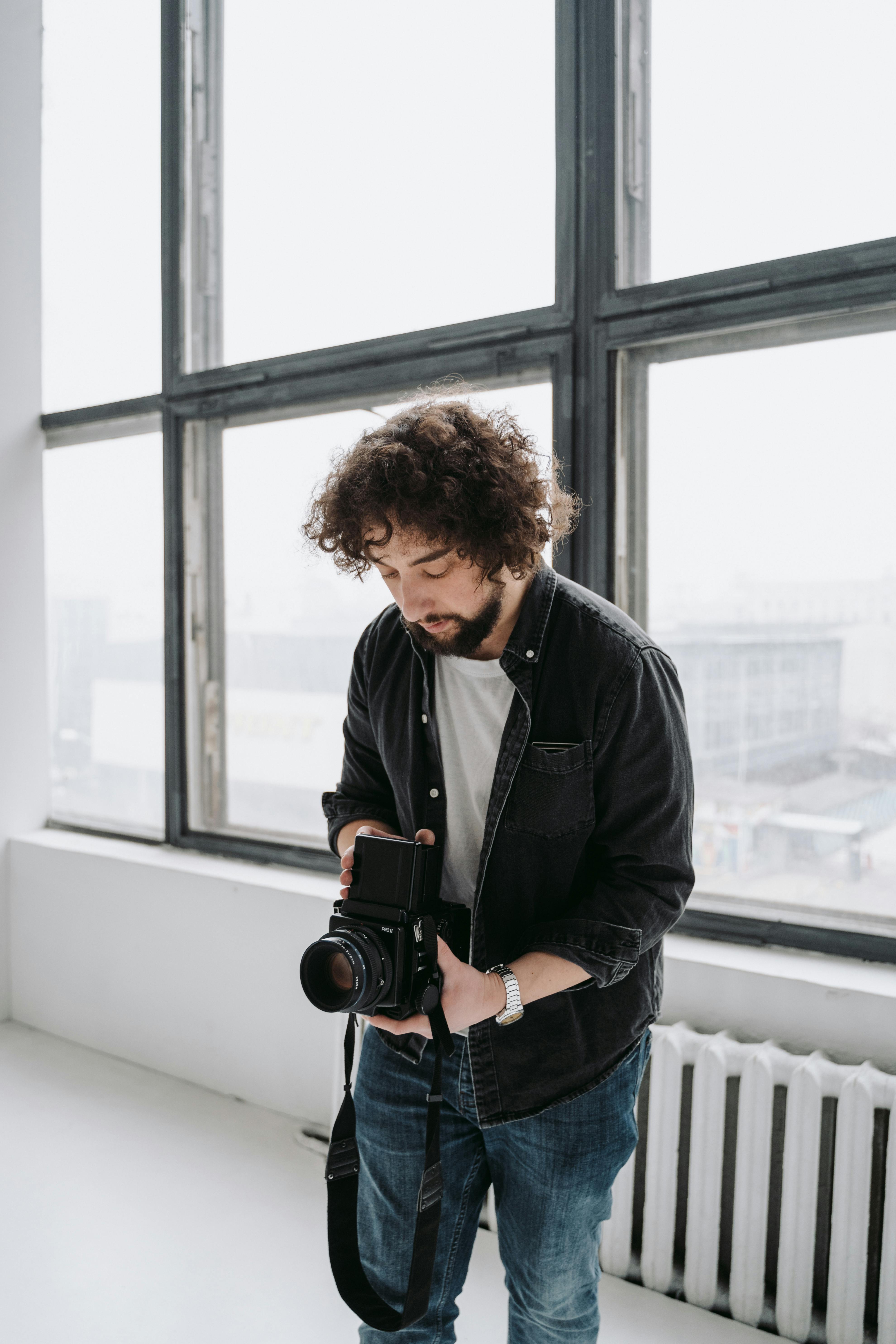 A Man Holding a Camera · Free Stock Photo