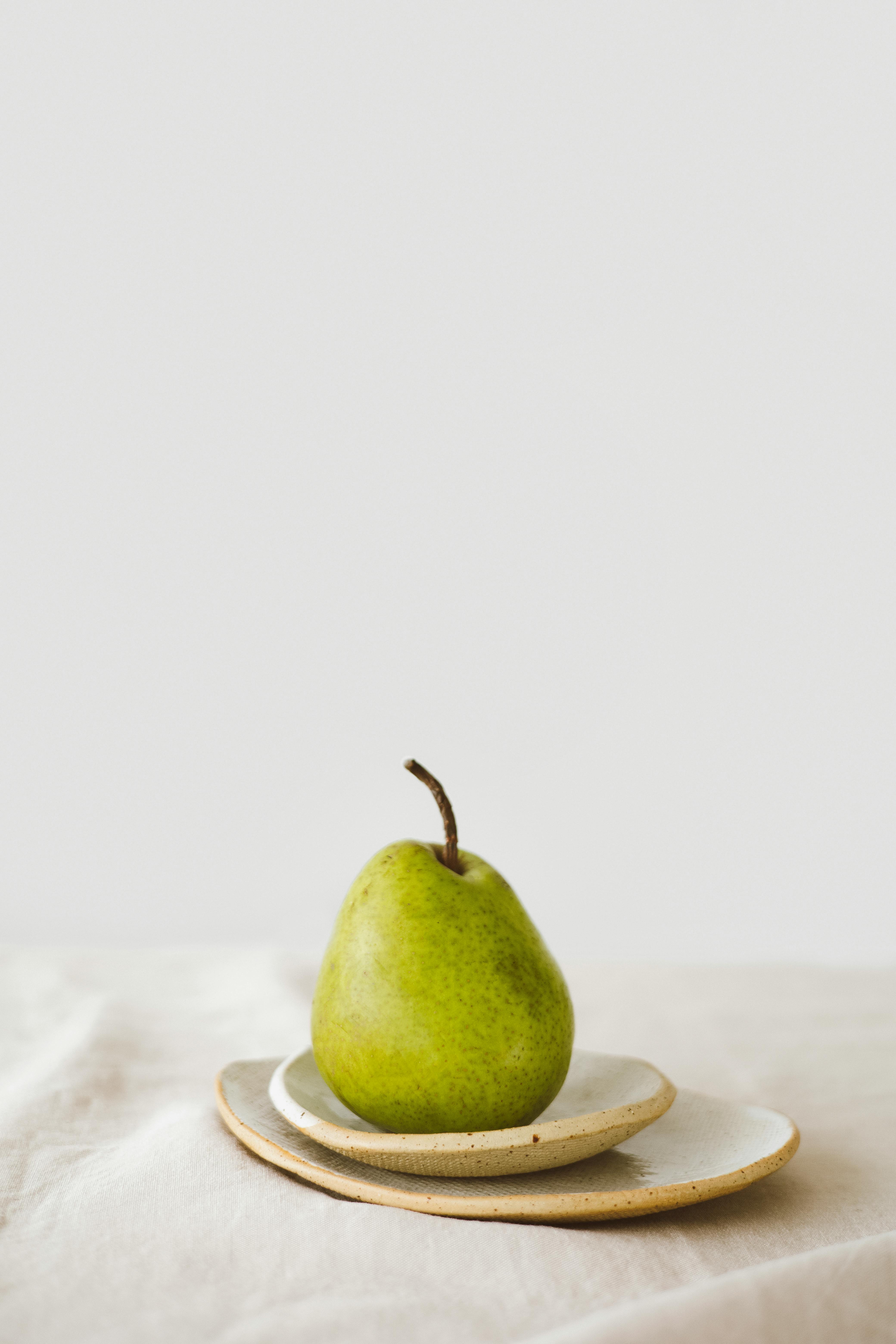 Close-Up Shot of a Pear on a Plate · Free Stock Photo