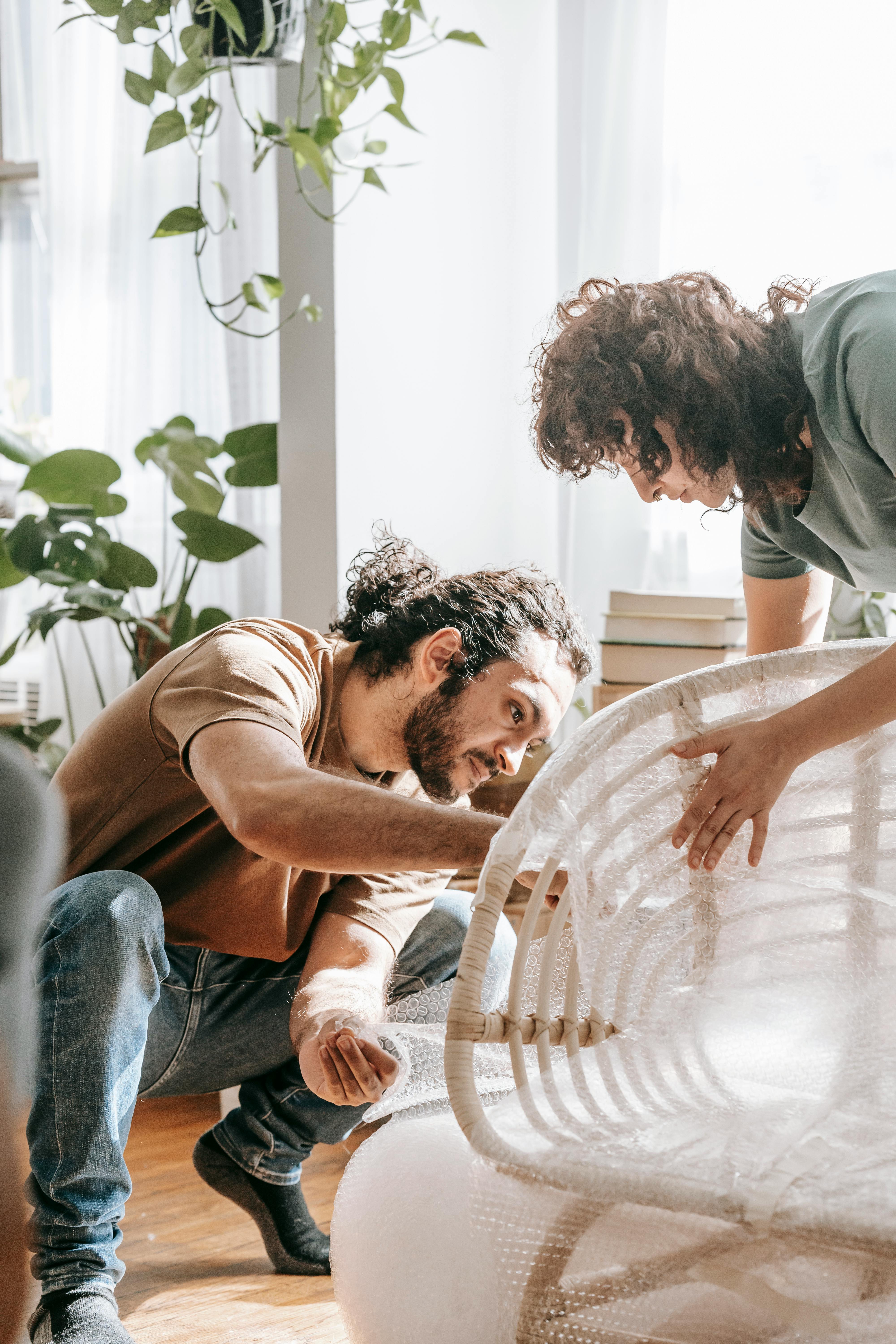 Woman Wrapping A Chair With Plastic · Free Stock Photo