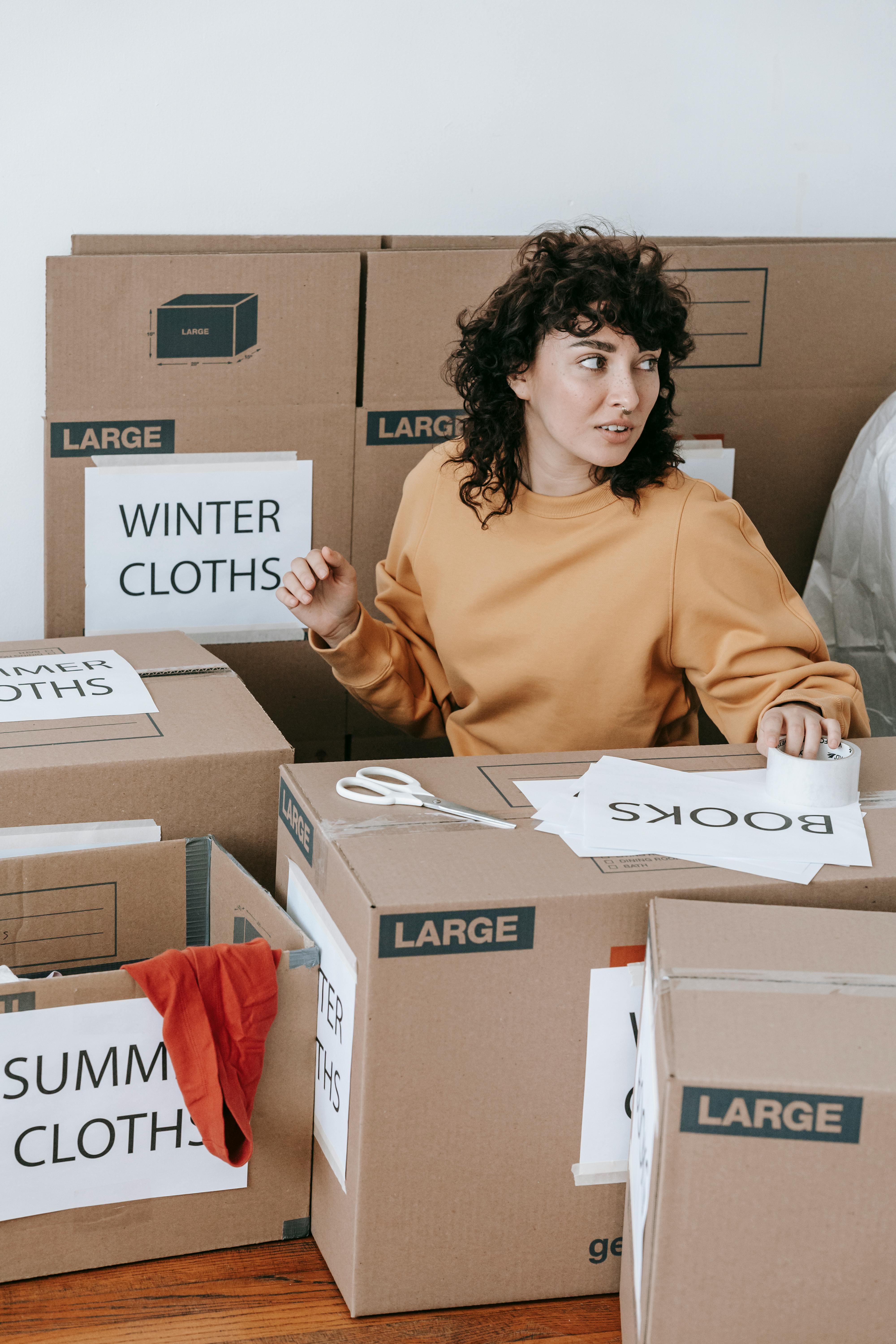 Couple Done Packing And Labeling Boxes · Free Stock Photo