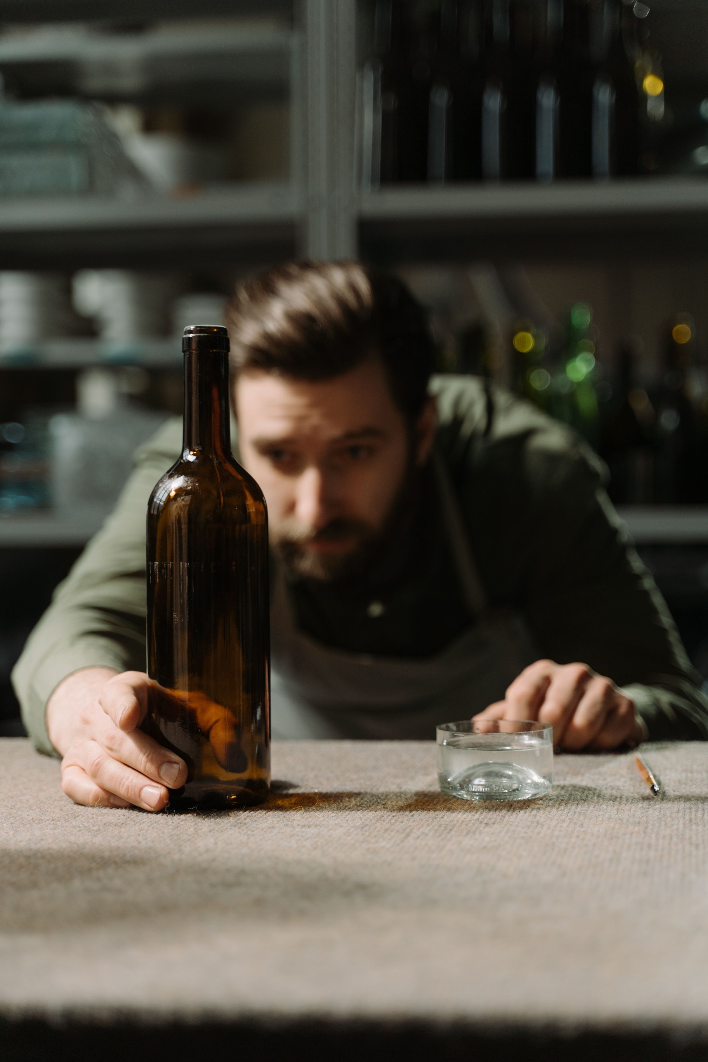 A Man Holding a Glass Bottle · Free Stock Photo