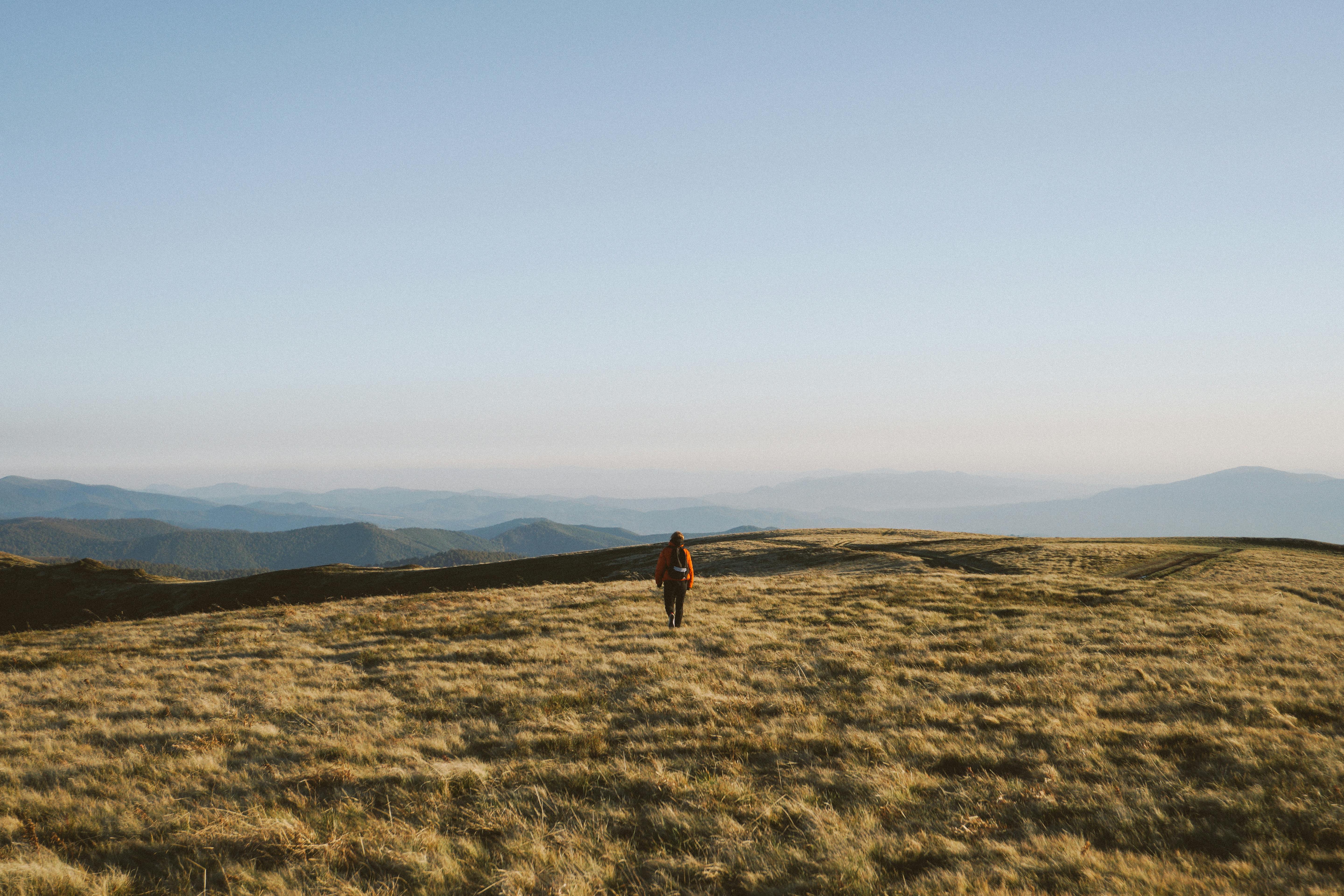 A Person Walking on a Field · Free Stock Photo
