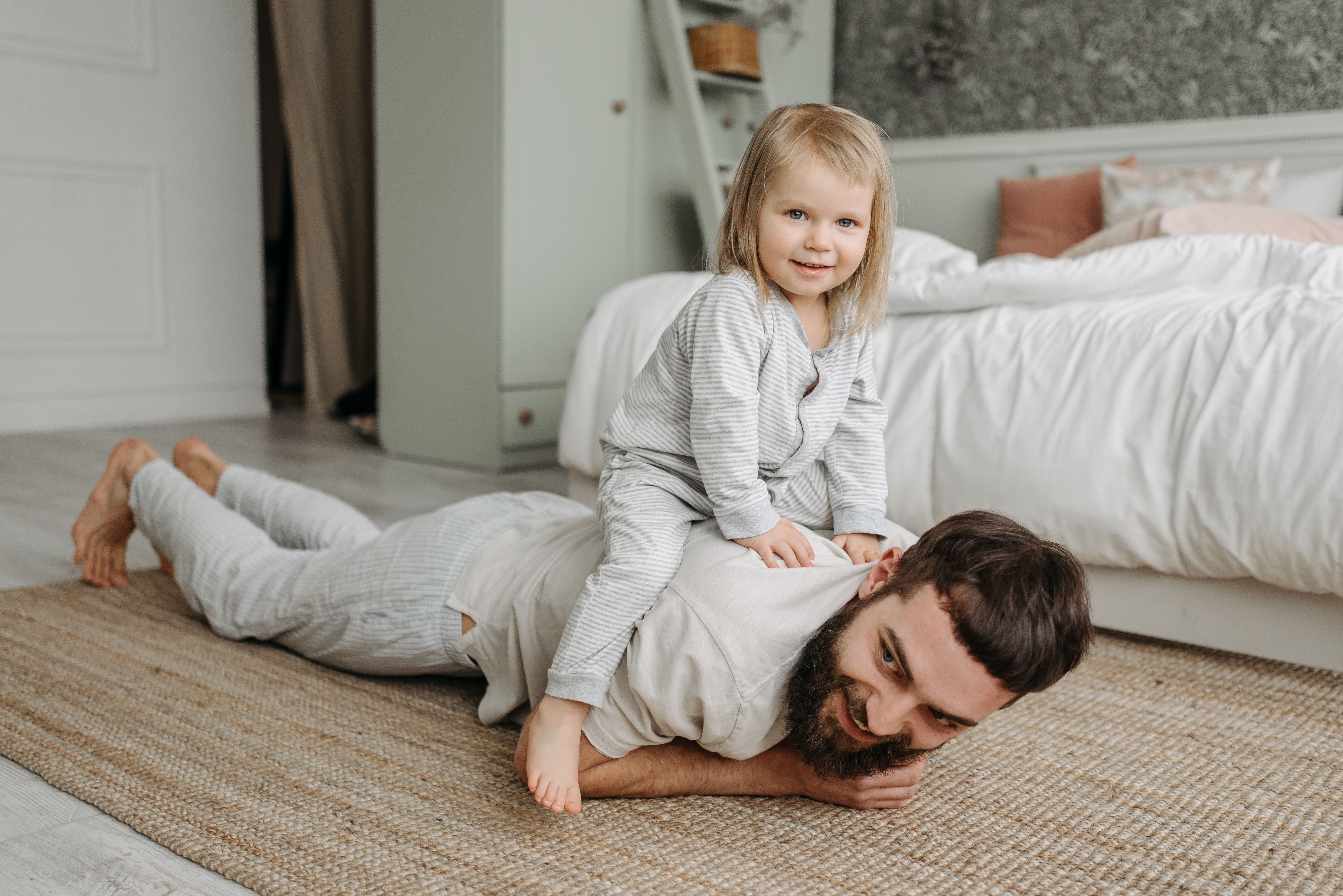 A Kid Sitting on His Father's Back · Free Stock Photo