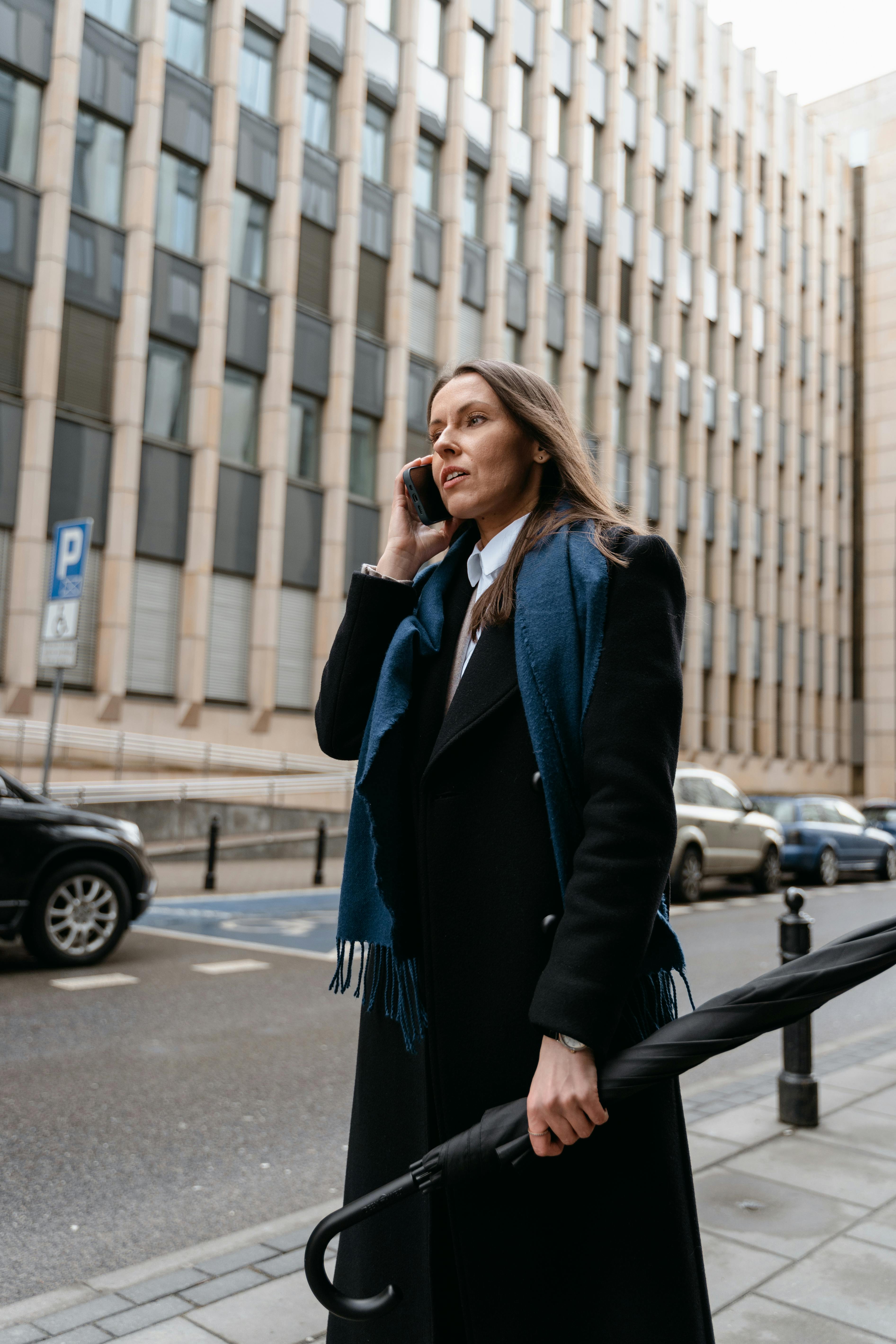 Woman in Black Coat Having a Phone Call · Free Stock Photo