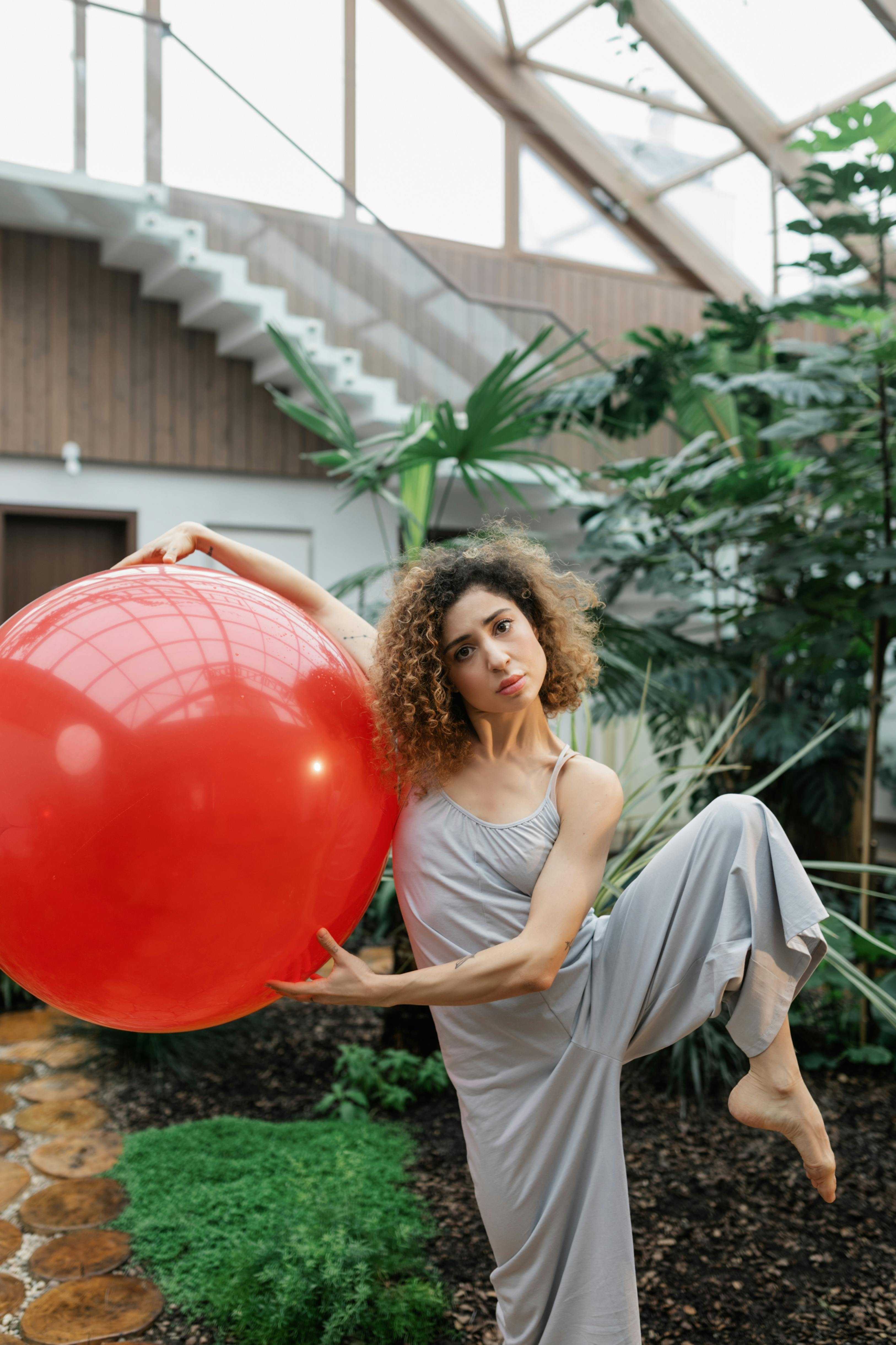 Woman Posing with an Exercise Ball · Free Stock Photo