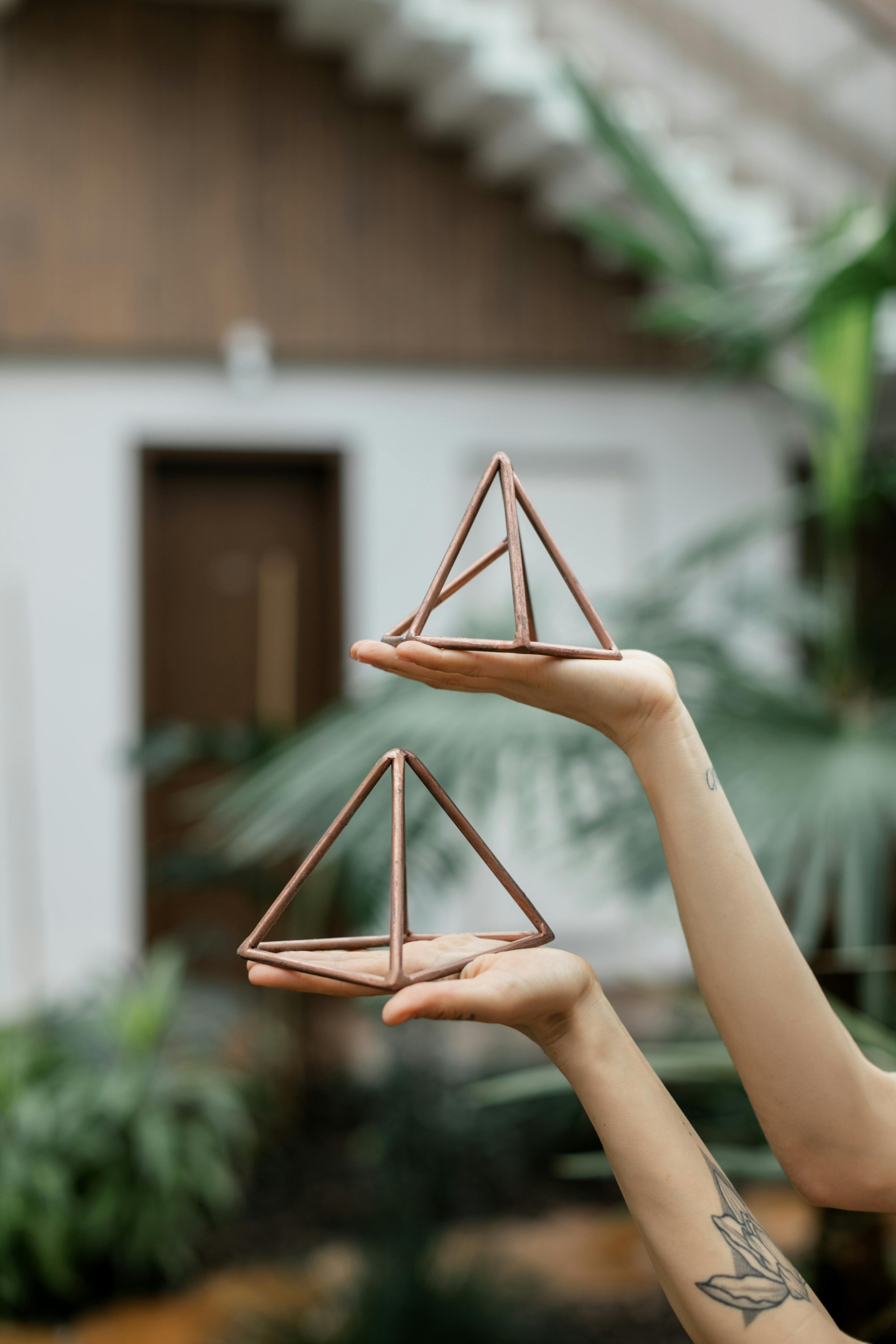Hands Holding Pyramids · Free Stock Photo