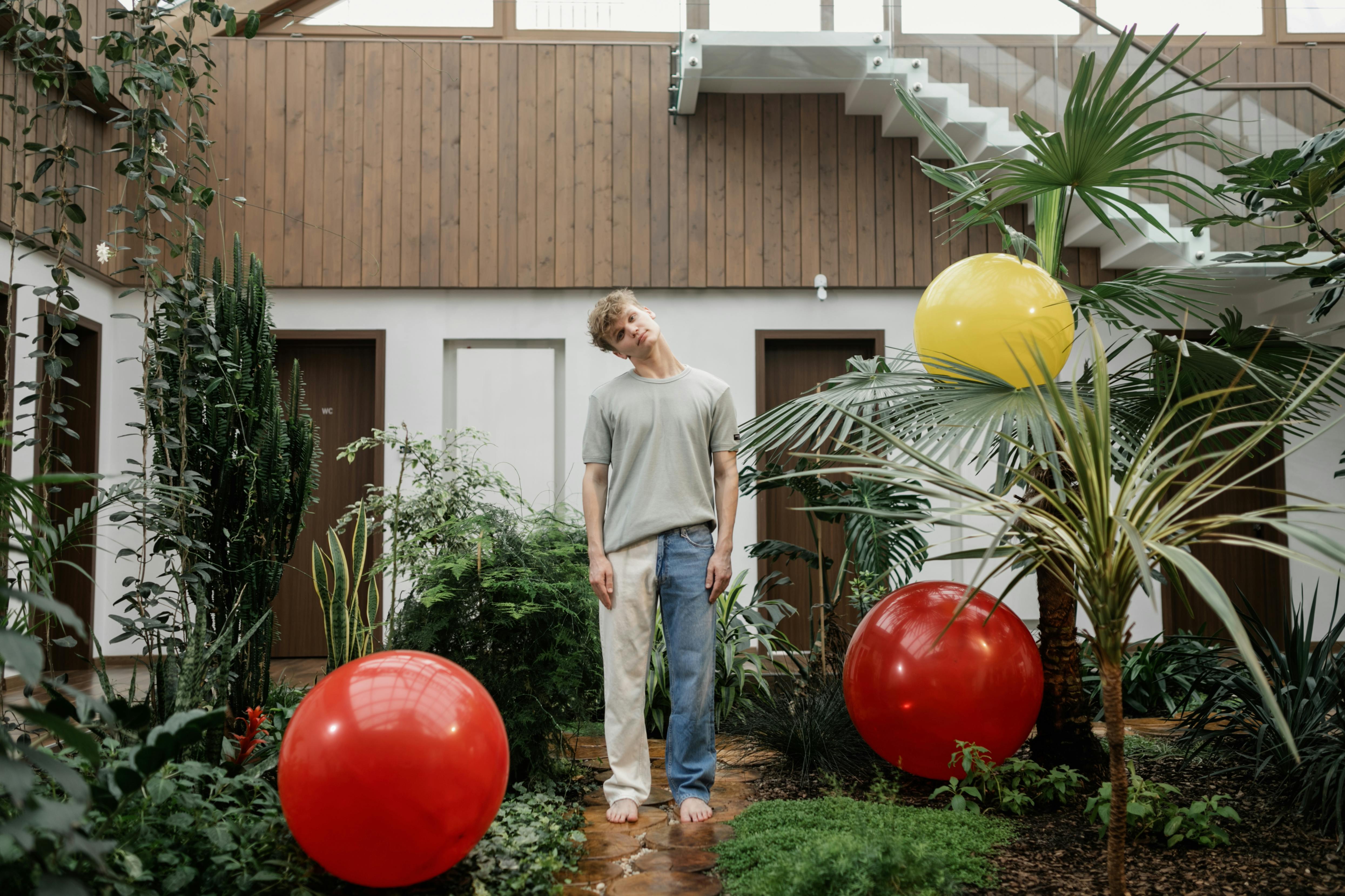 Man Tilting His Head to the Right in a Garden · Free Stock Photo