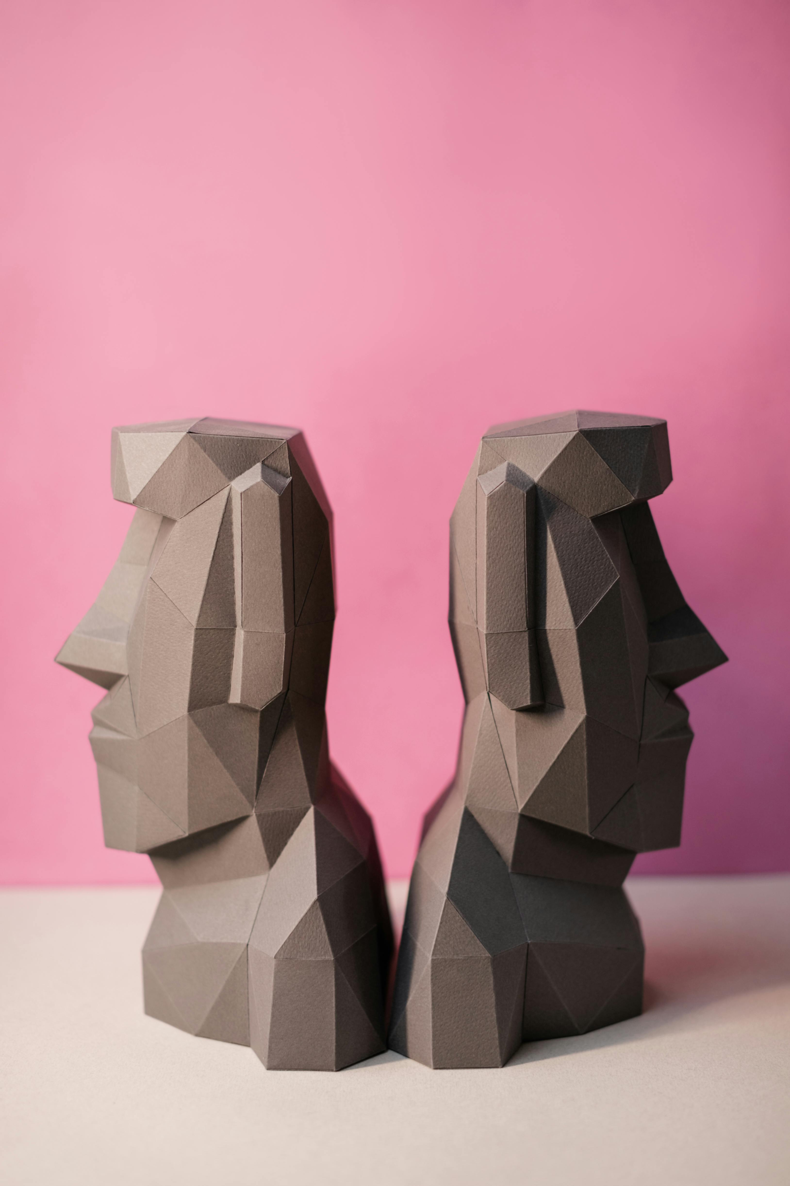 Geometric Human Head Figures on Pink Background · Free Stock Photo