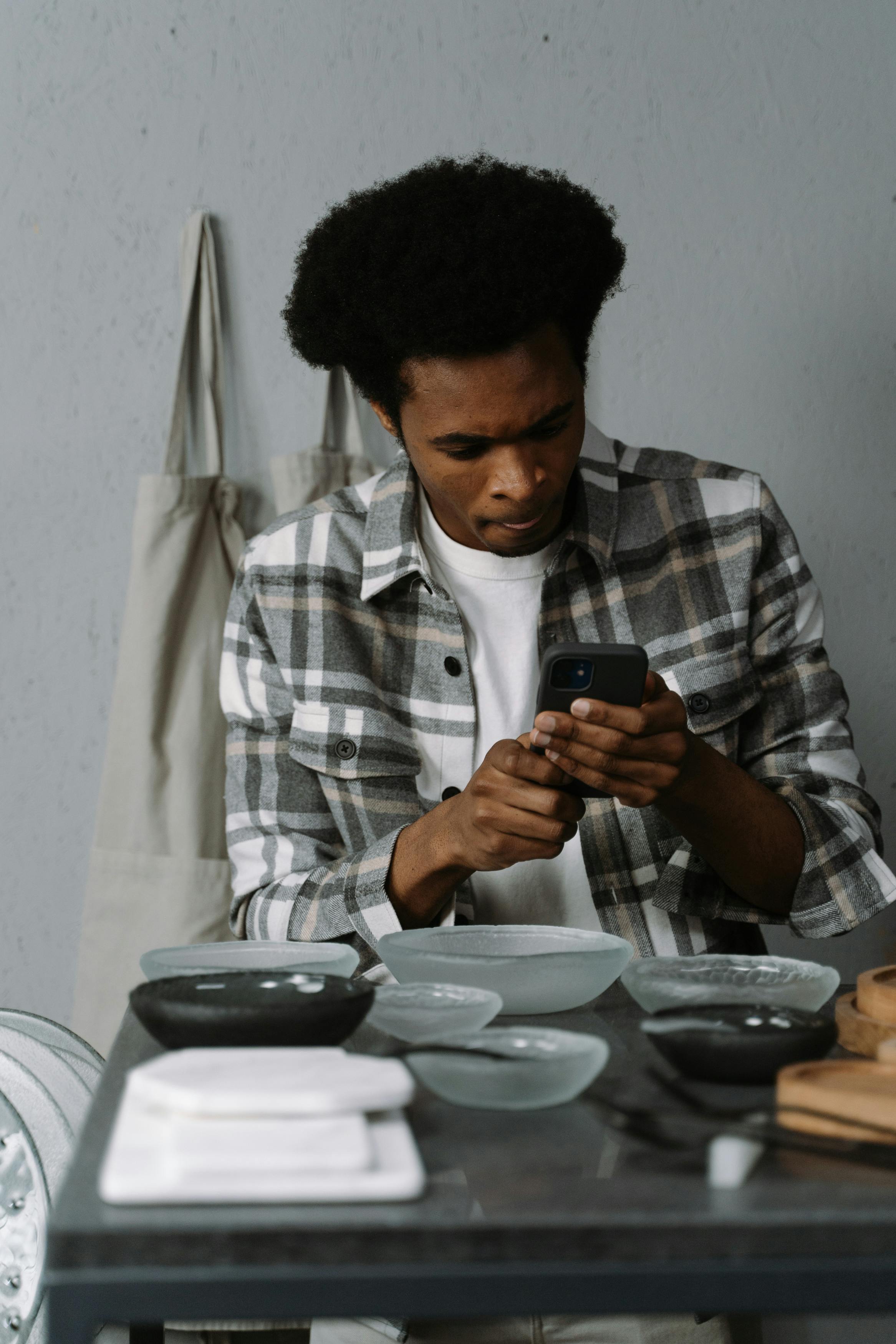 Man Sitting on a Chair in Front of Computer Laptop Using Cellphone ...