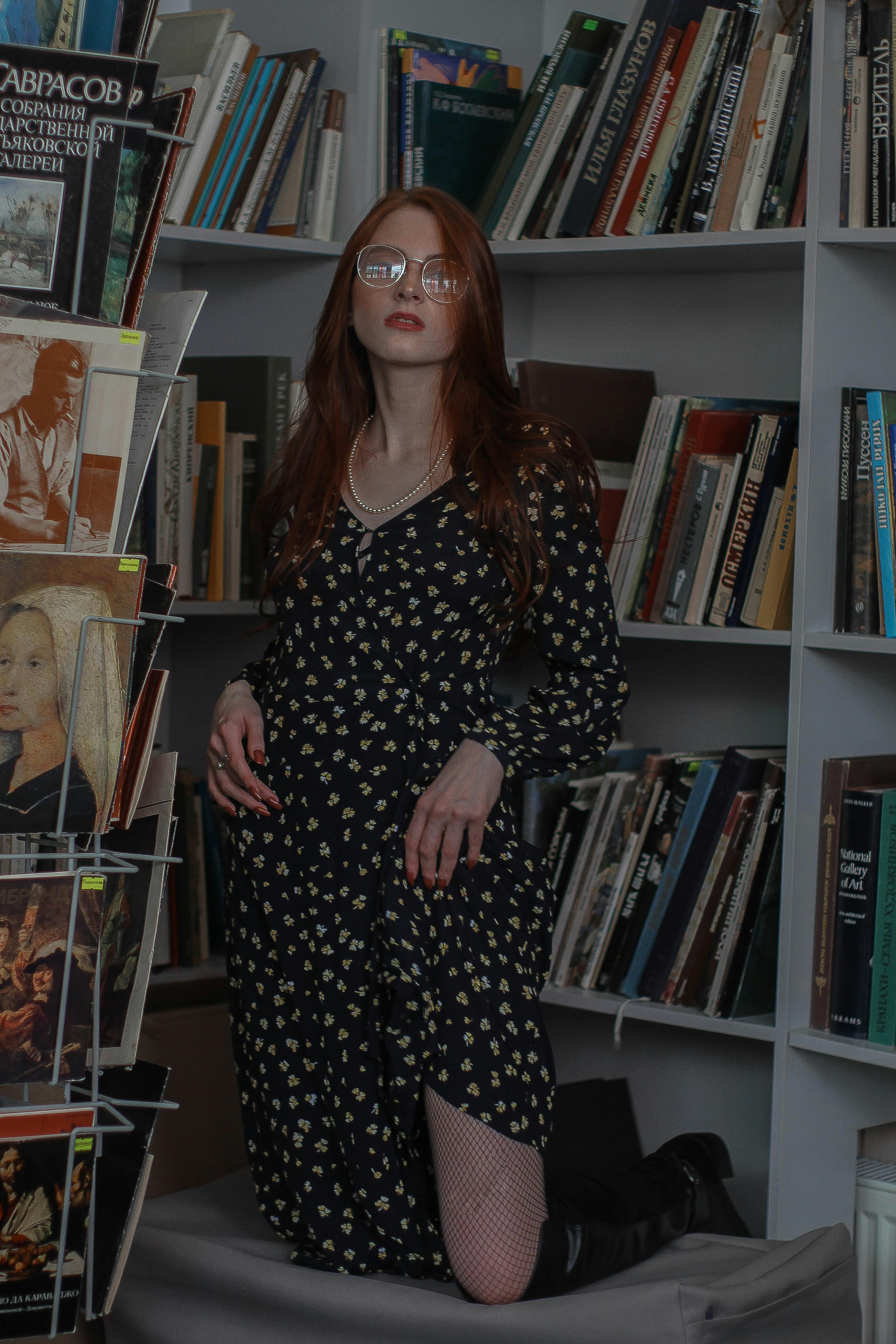 Feminine woman with long hair in library · Free Stock Photo