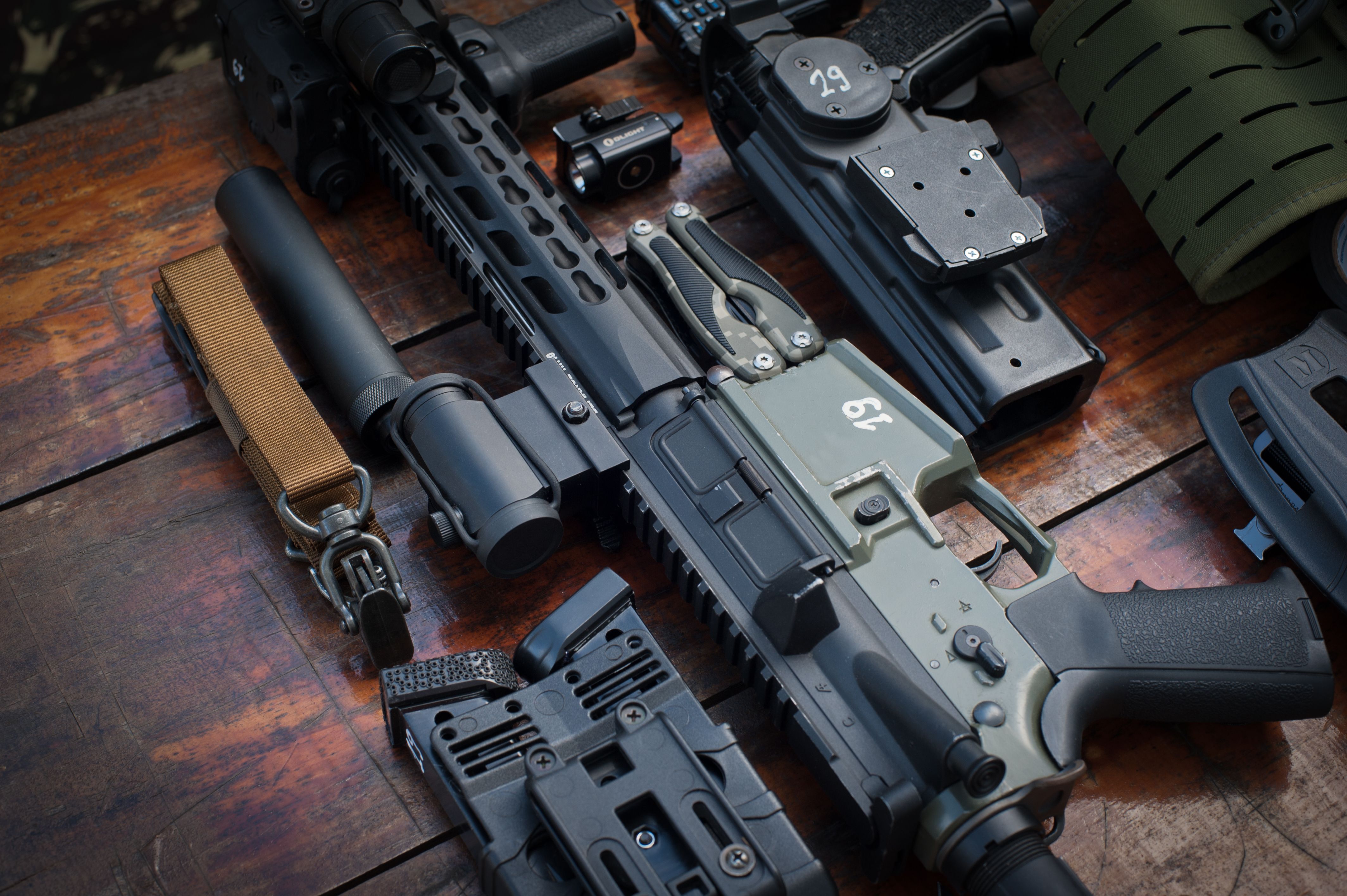 Close-Up Shot of Firearms on Wooden Surface · Free Stock Photo