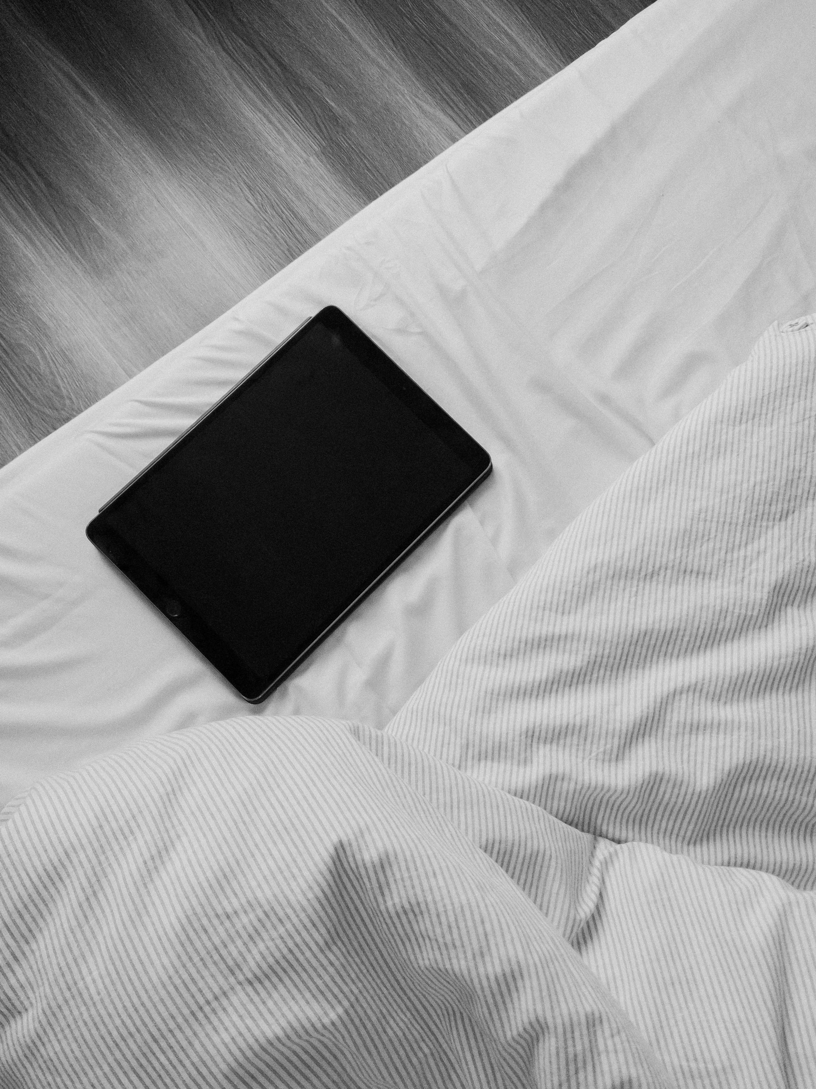A Black Tablet on the Bed · Free Stock Photo