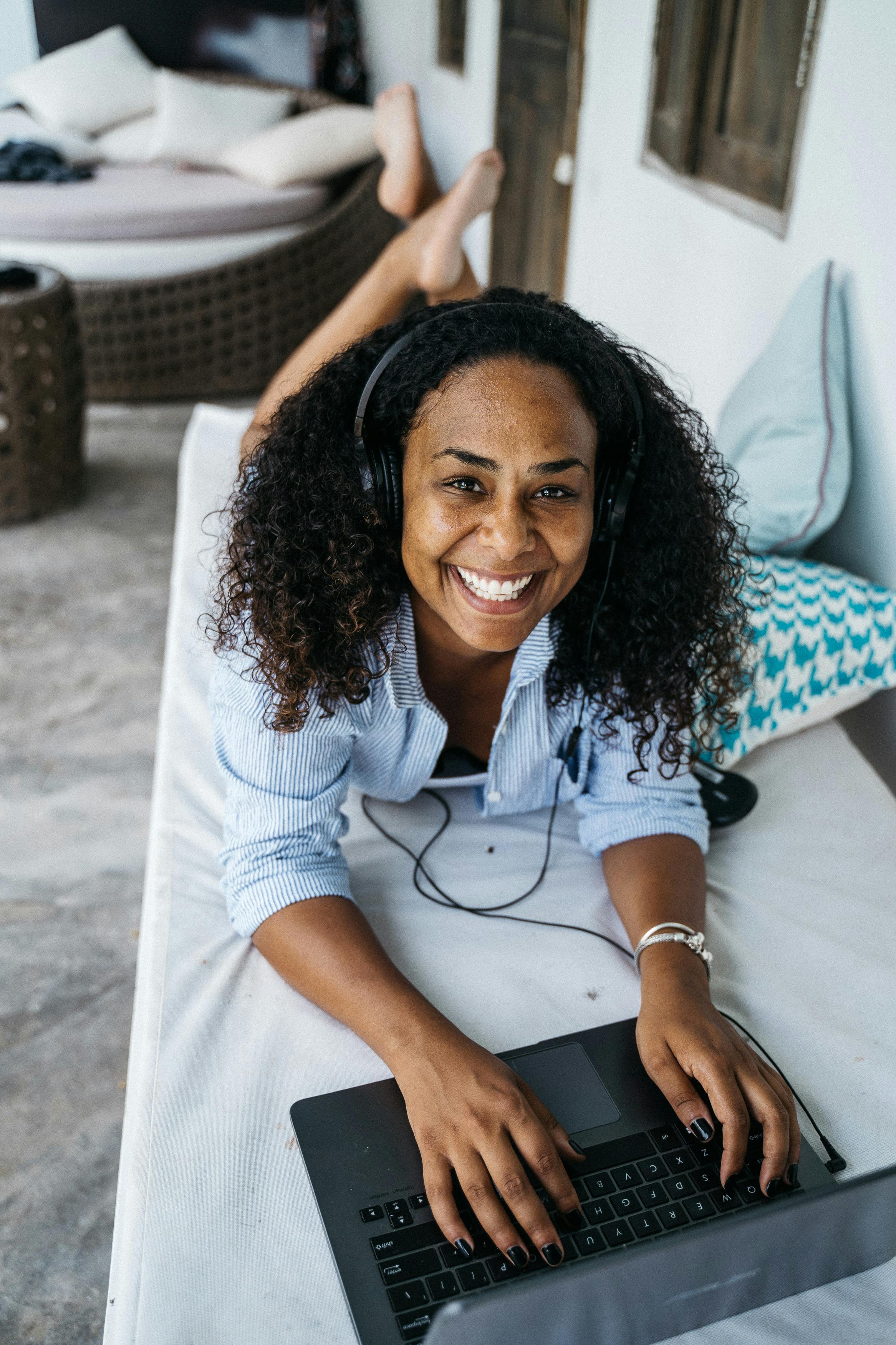 Woman Wearing Earpiece Using White Laptop Computer · Free Stock Photo