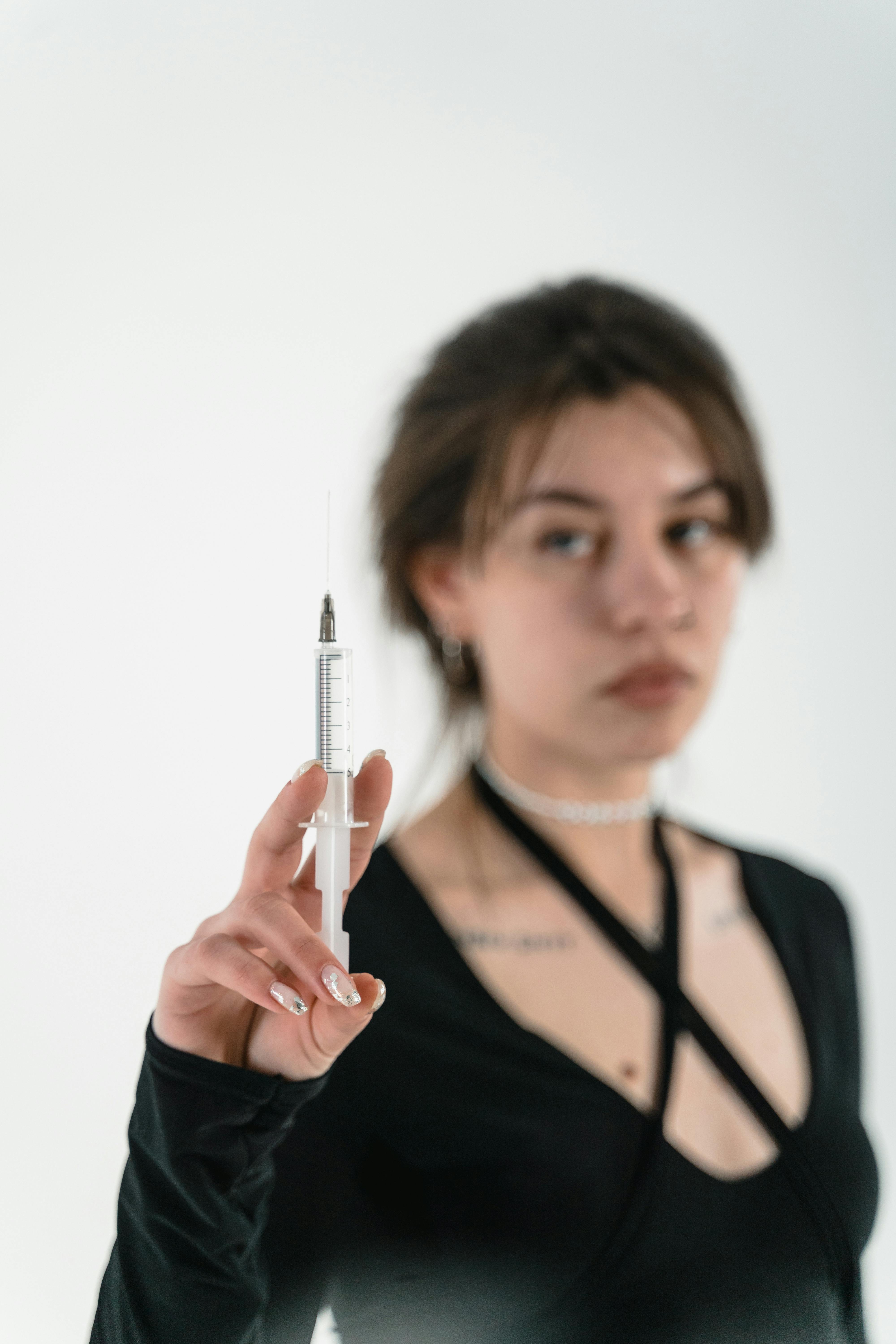 Woman Holding Syringe · Free Stock Photo