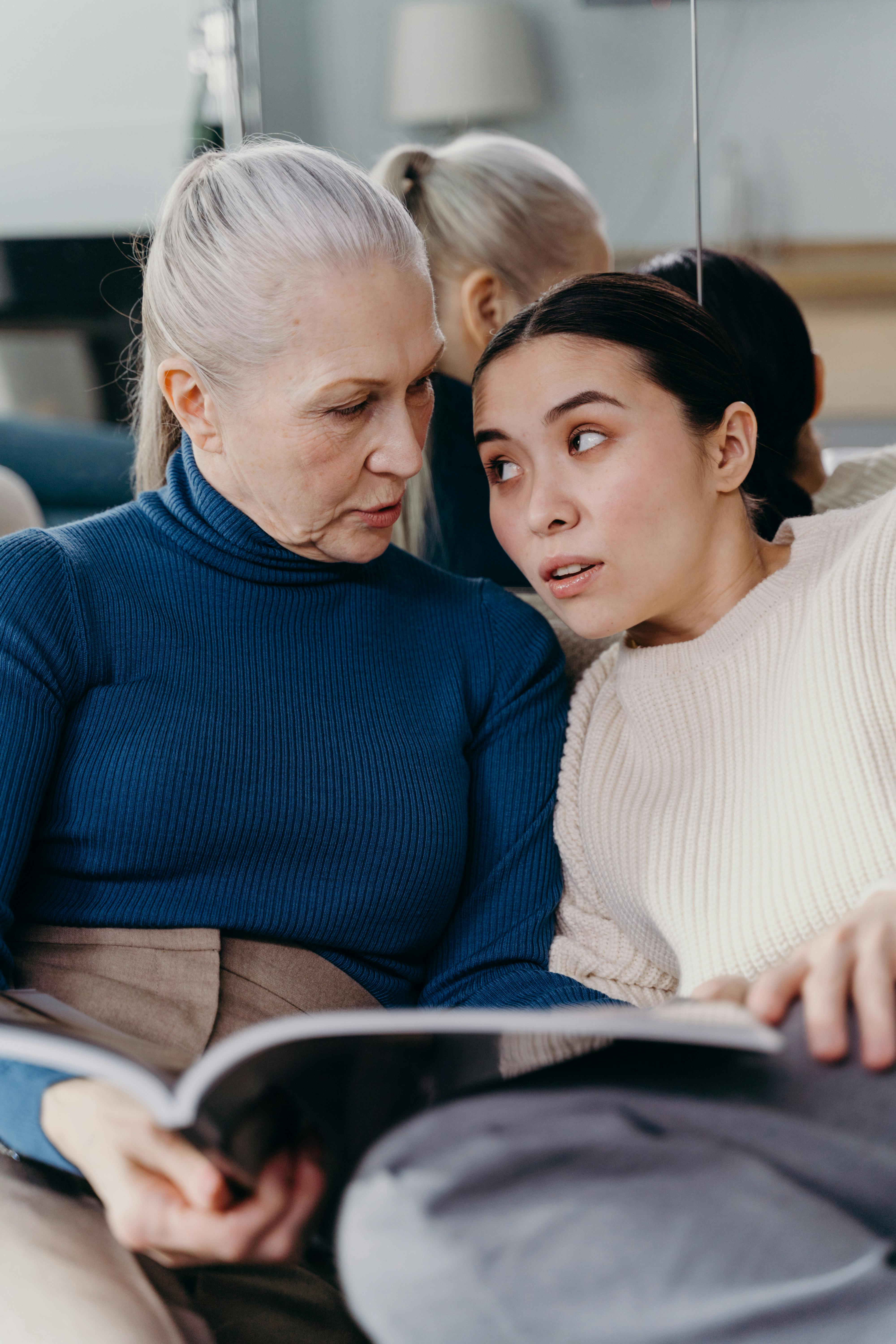 Two Sitting Women Wearing Sweaters · Free Stock Photo