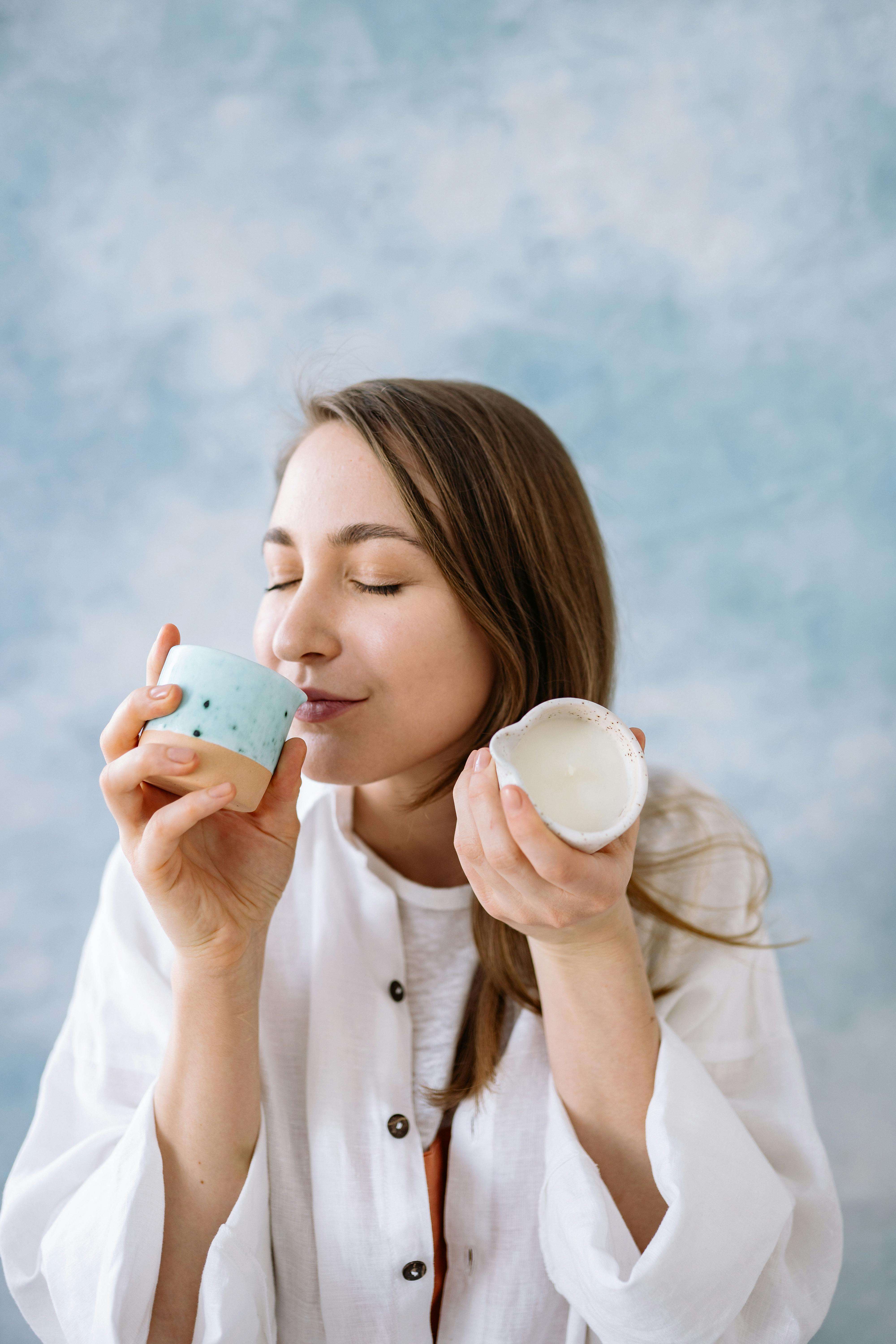 Woman Smelling A Scented Candle · Free Stock Photo