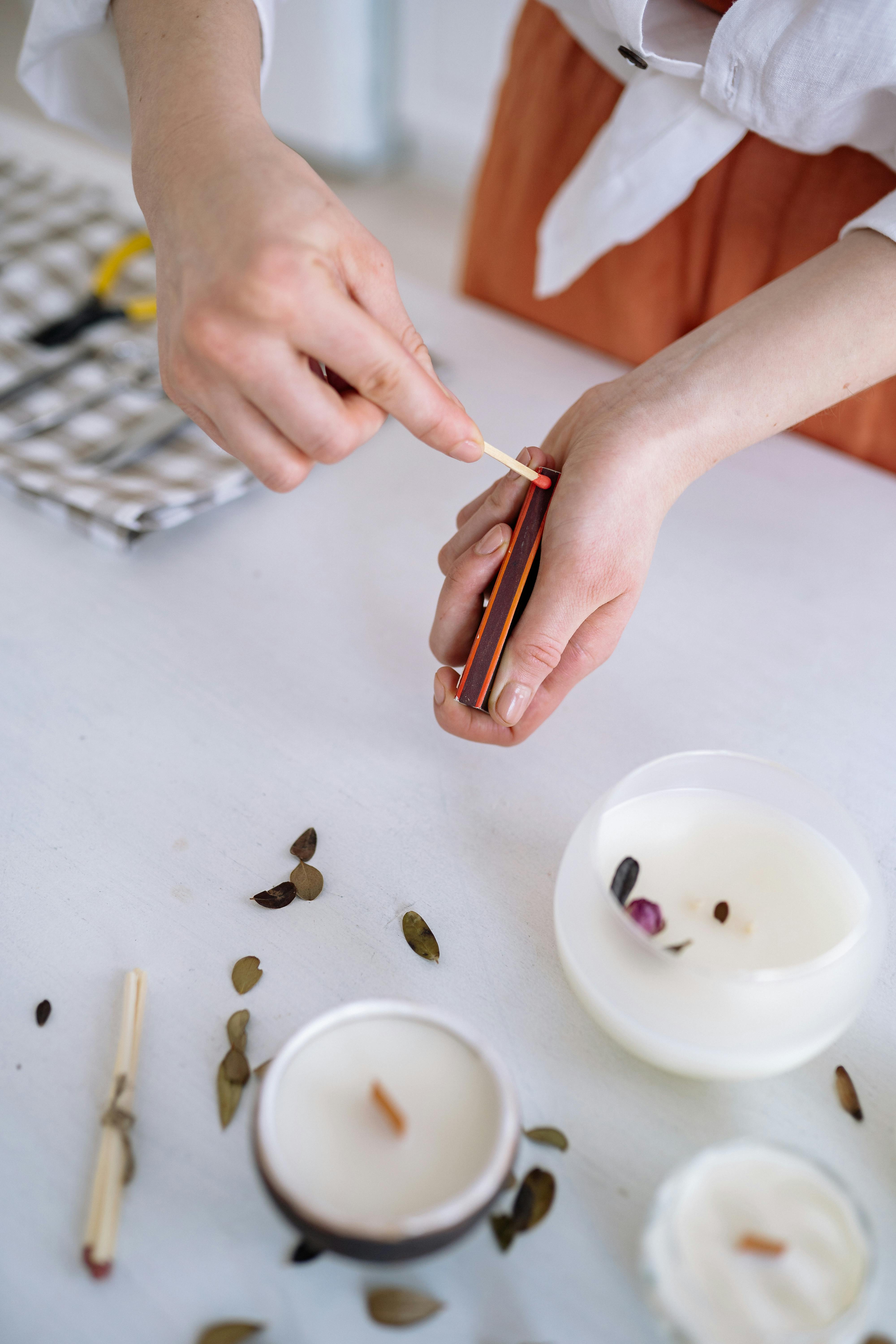 A Person Lighting a Match Stick · Free Stock Photo