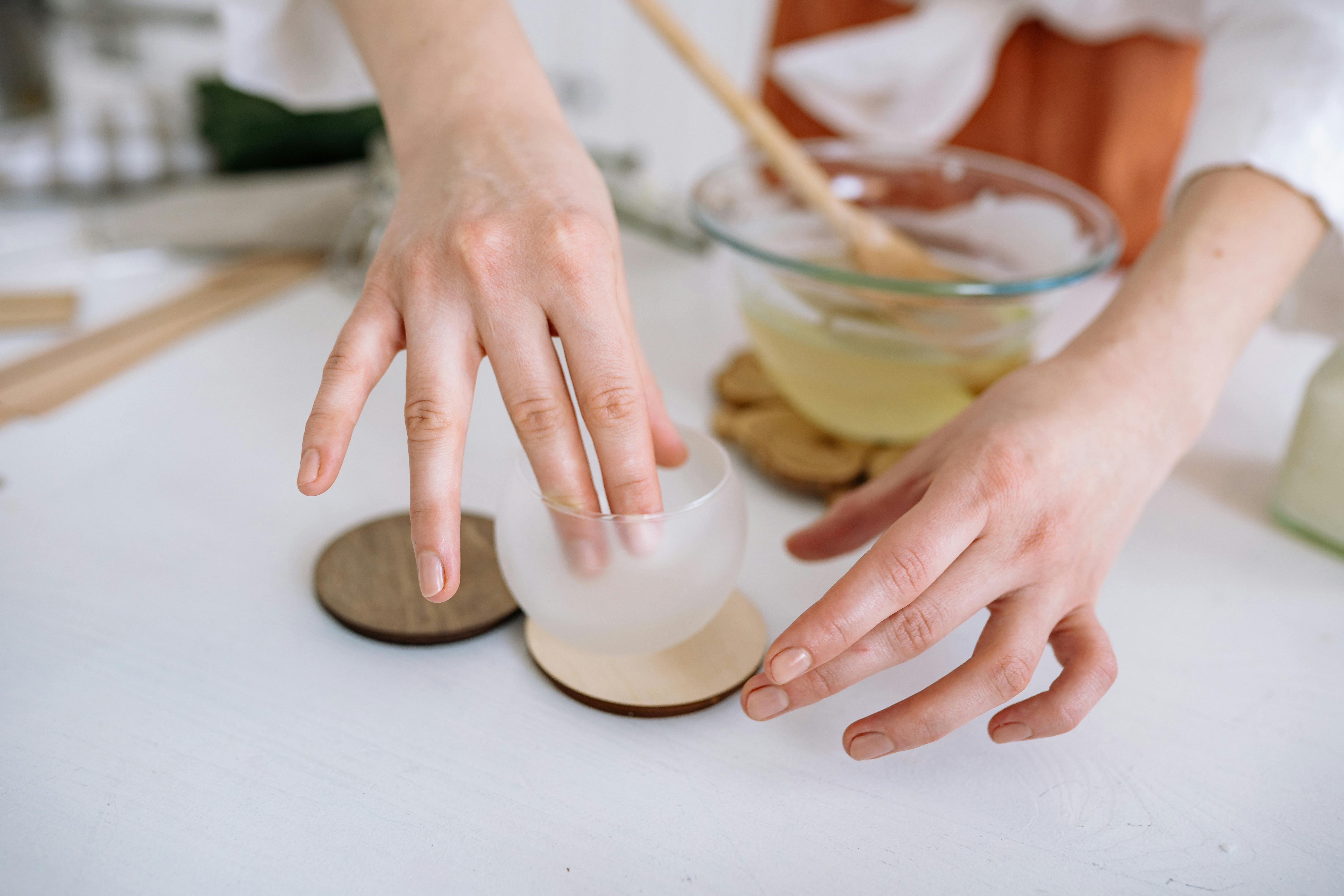 Person Holding Popsicle Stick Mixing Liquid · Free Stock Photo