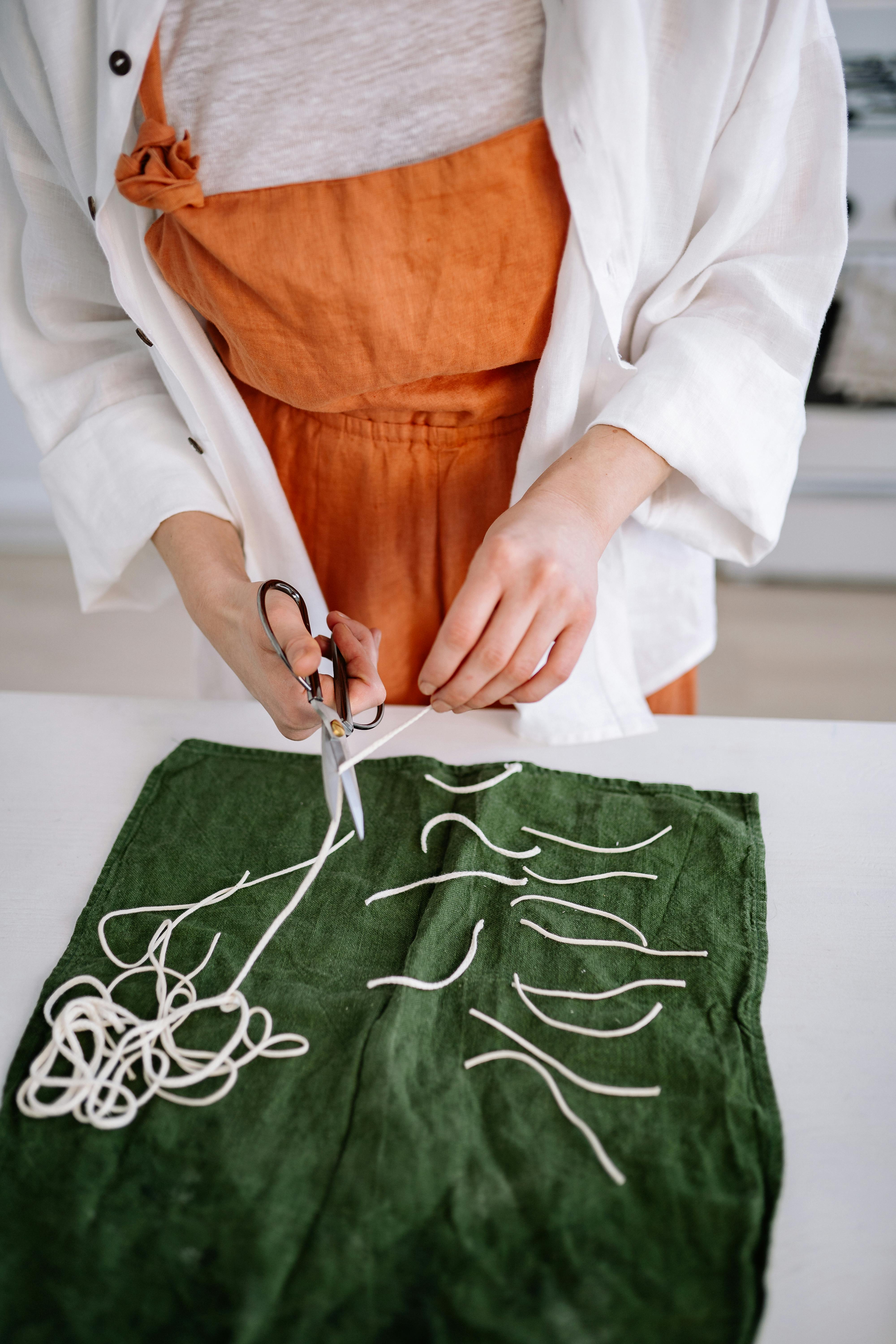 Person Cutting Fabric · Free Stock Photo