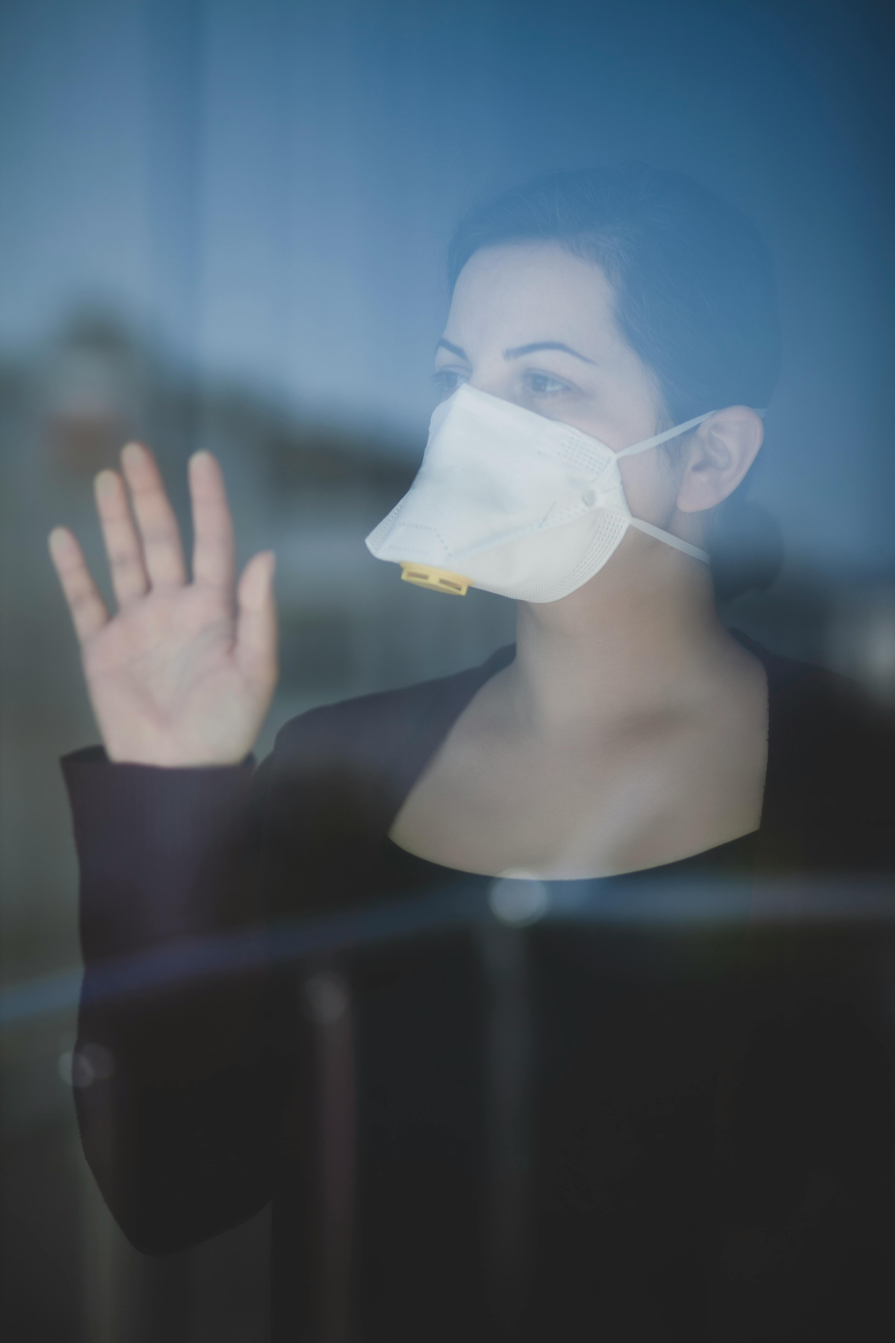 A Woman Wearing a Black Leather Jacket and a Face Mask · Free Stock Photo