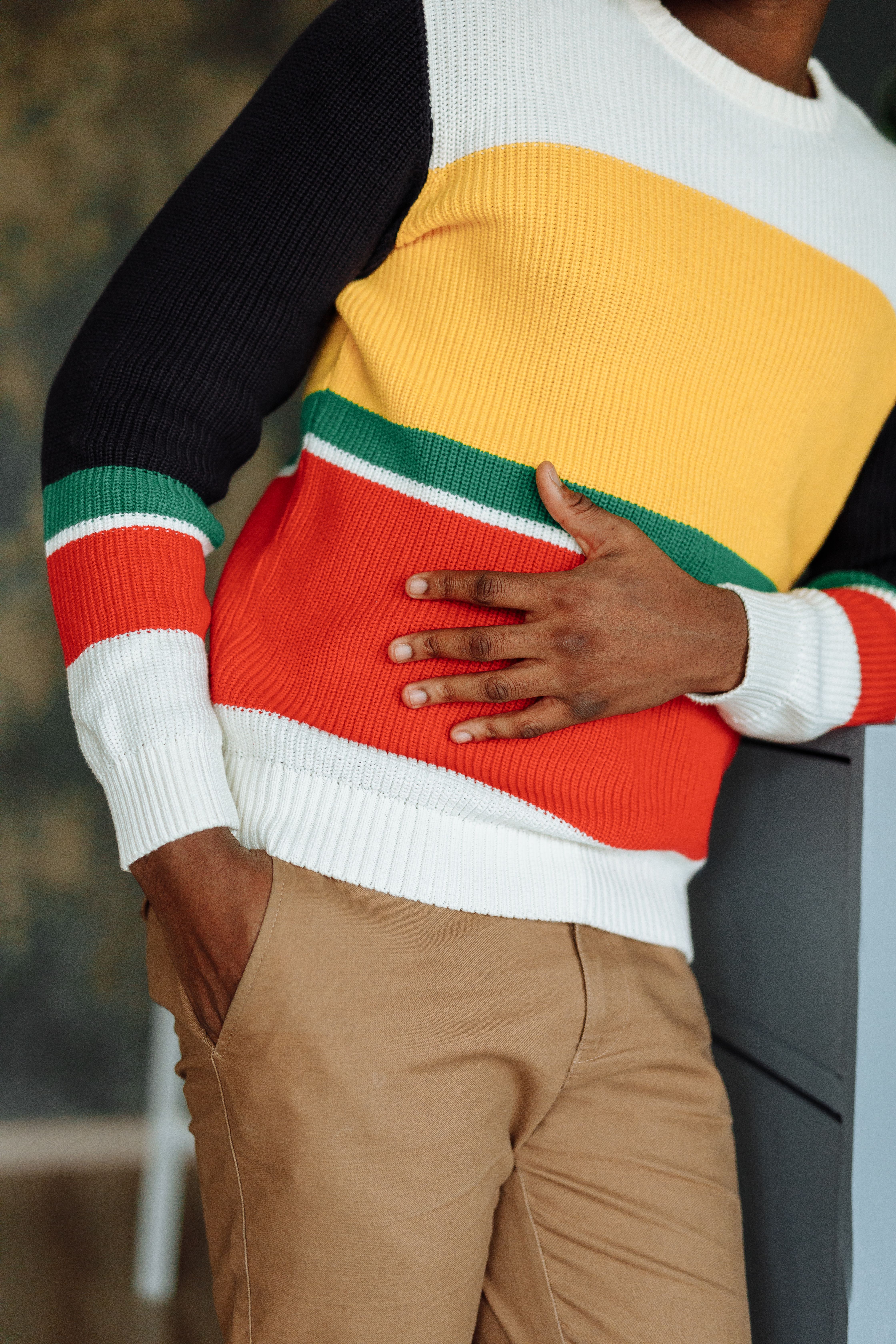 Person Wearing a Striped Sweater with Hand in Pocket · Free Stock Photo