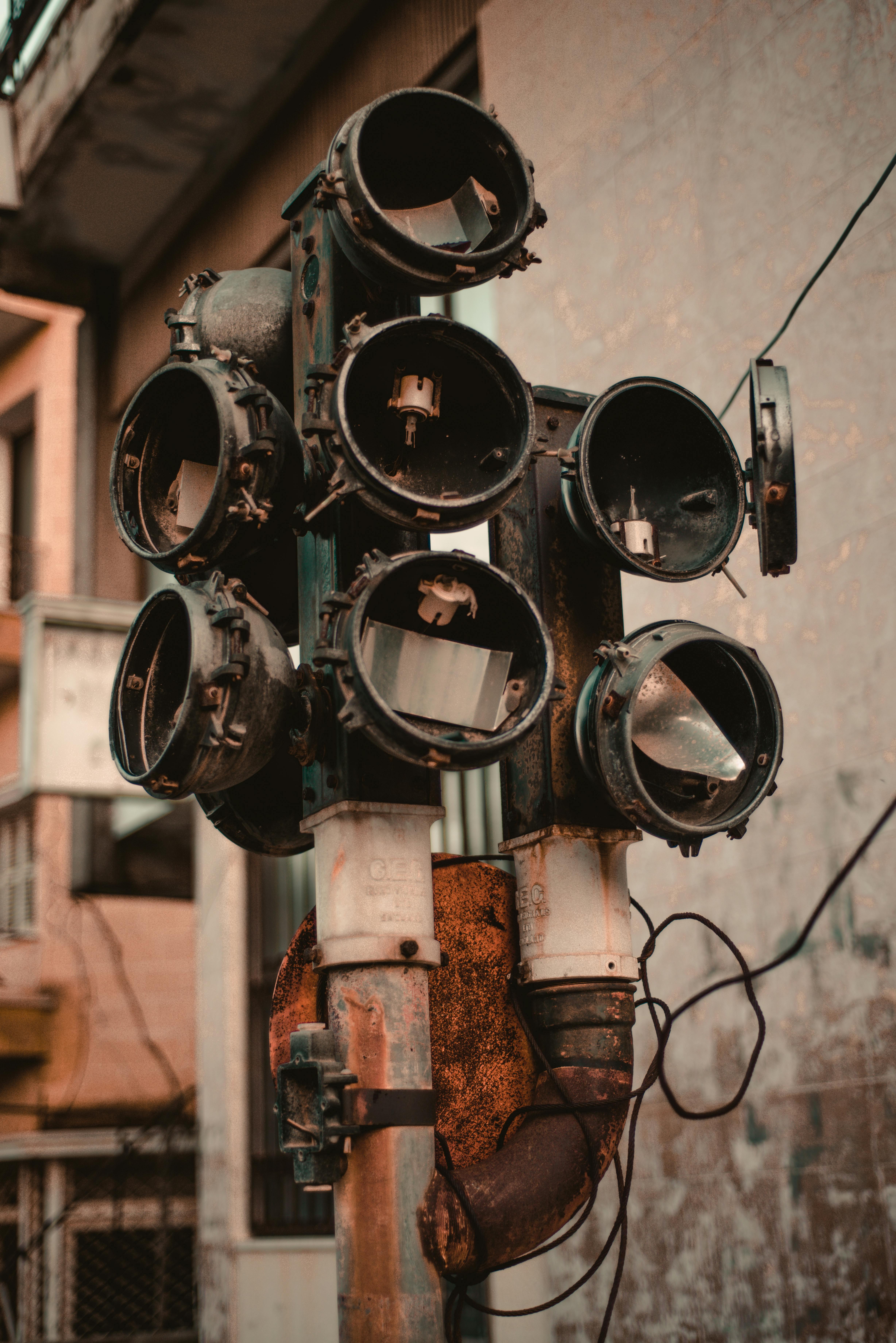Old Traffic Lights Housing on a Rusty Steel Pole · Free Stock Photo