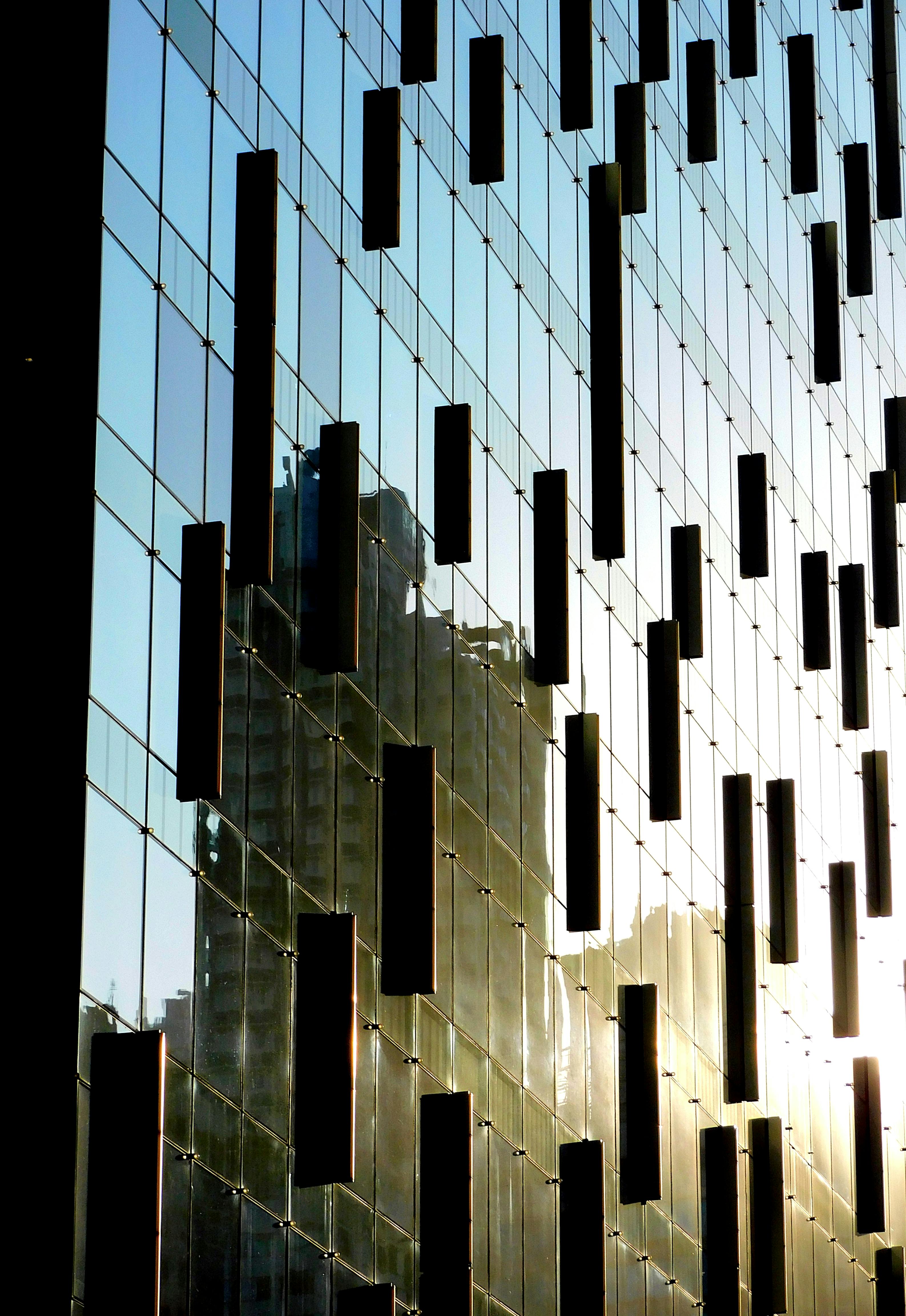 Reflection of buildings and sundown sky in mirrored facade of modern ...
