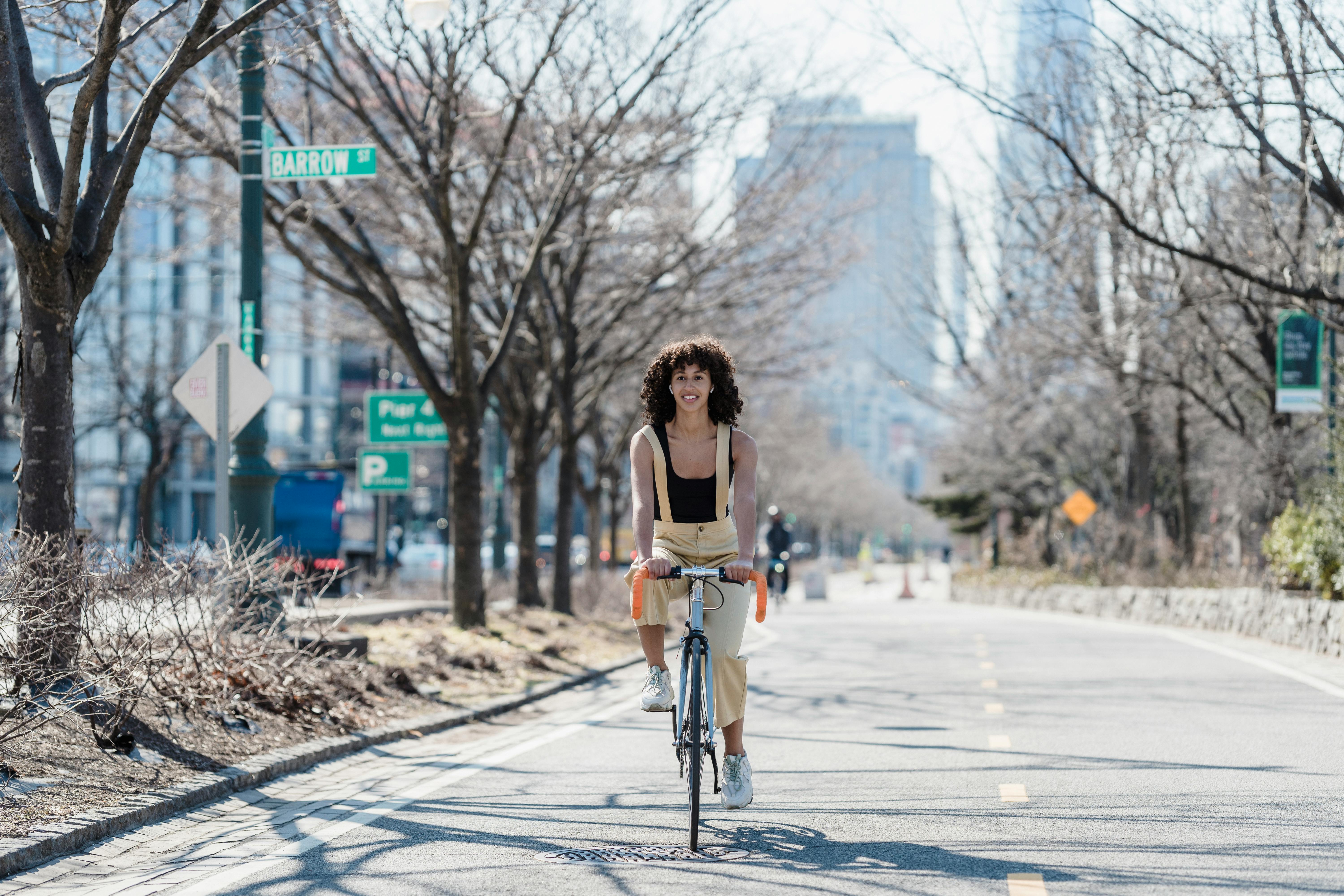 A Woman Riding a Road Bike · Free Stock Photo