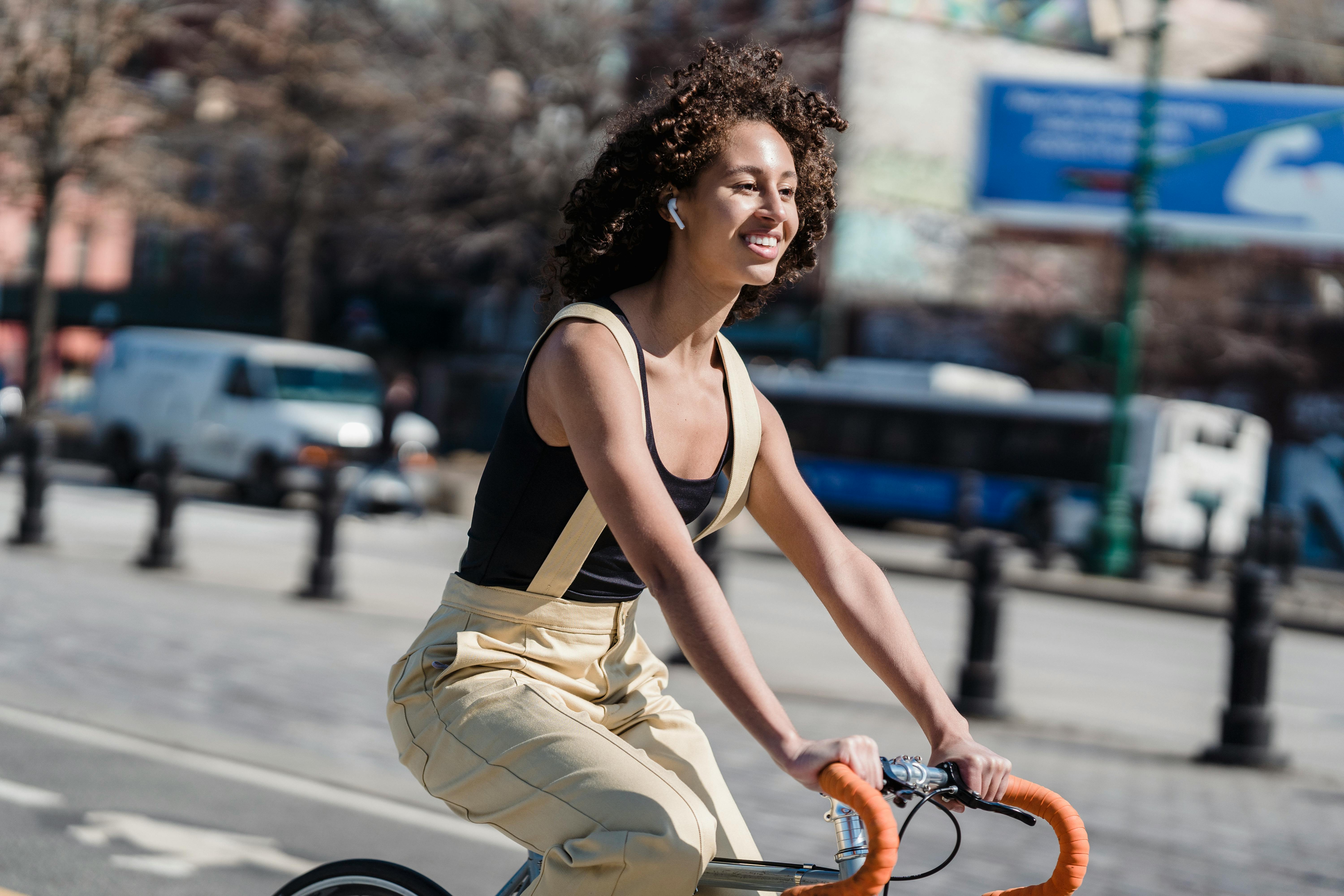 A Woman Riding a Road Bike · Free Stock Photo