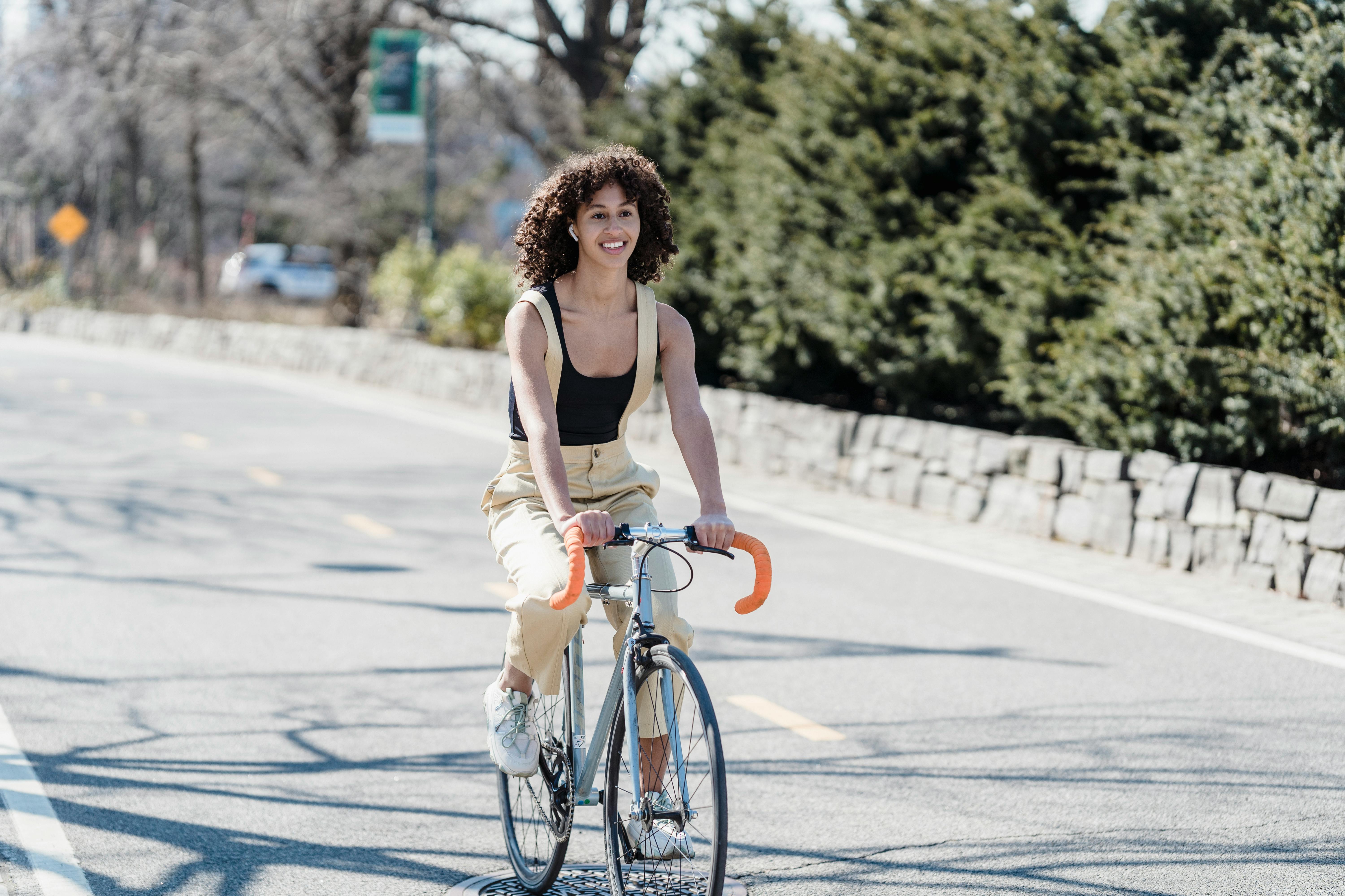 A Woman Riding a Road Bike · Free Stock Photo