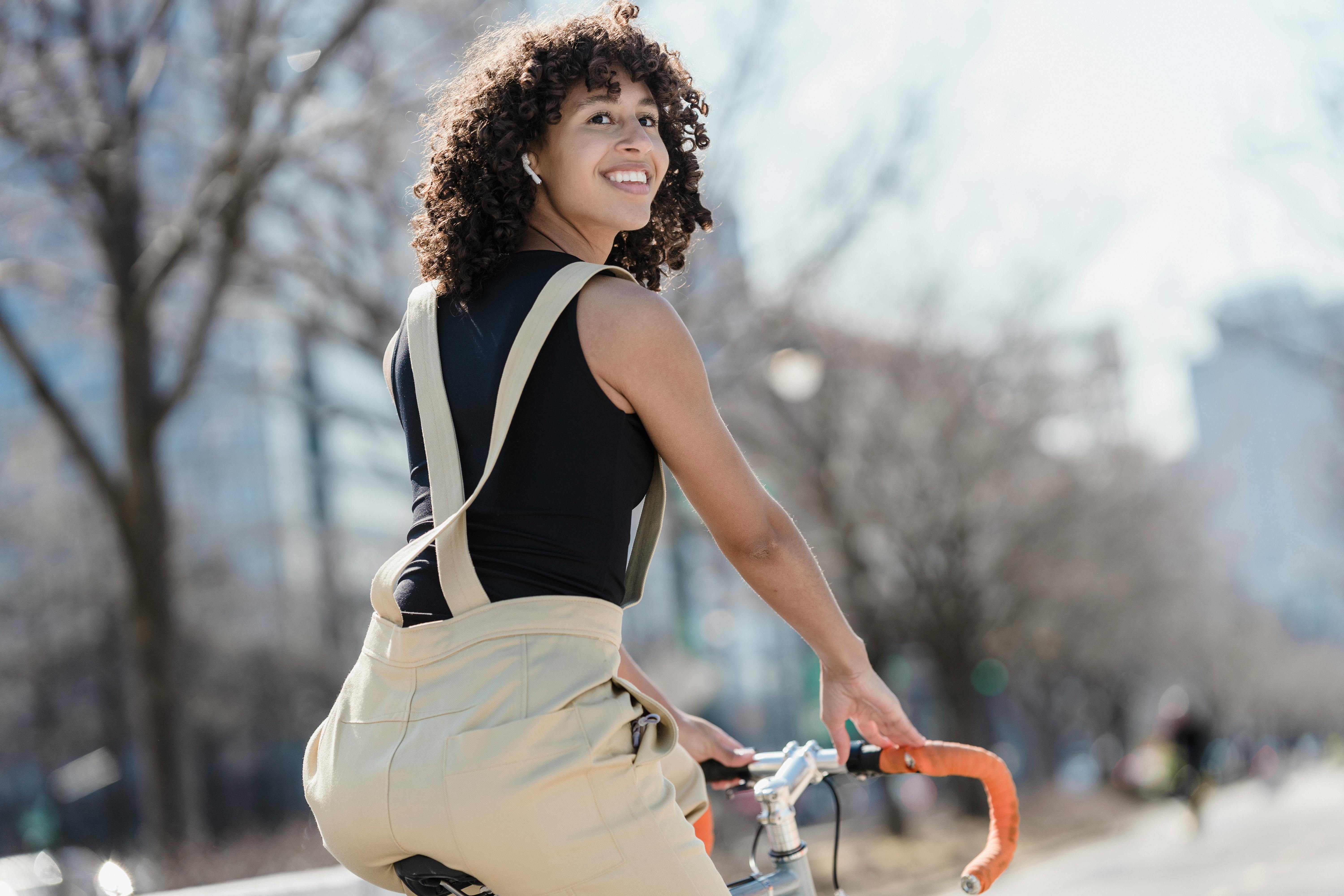 A Woman Riding a Road Bike · Free Stock Photo