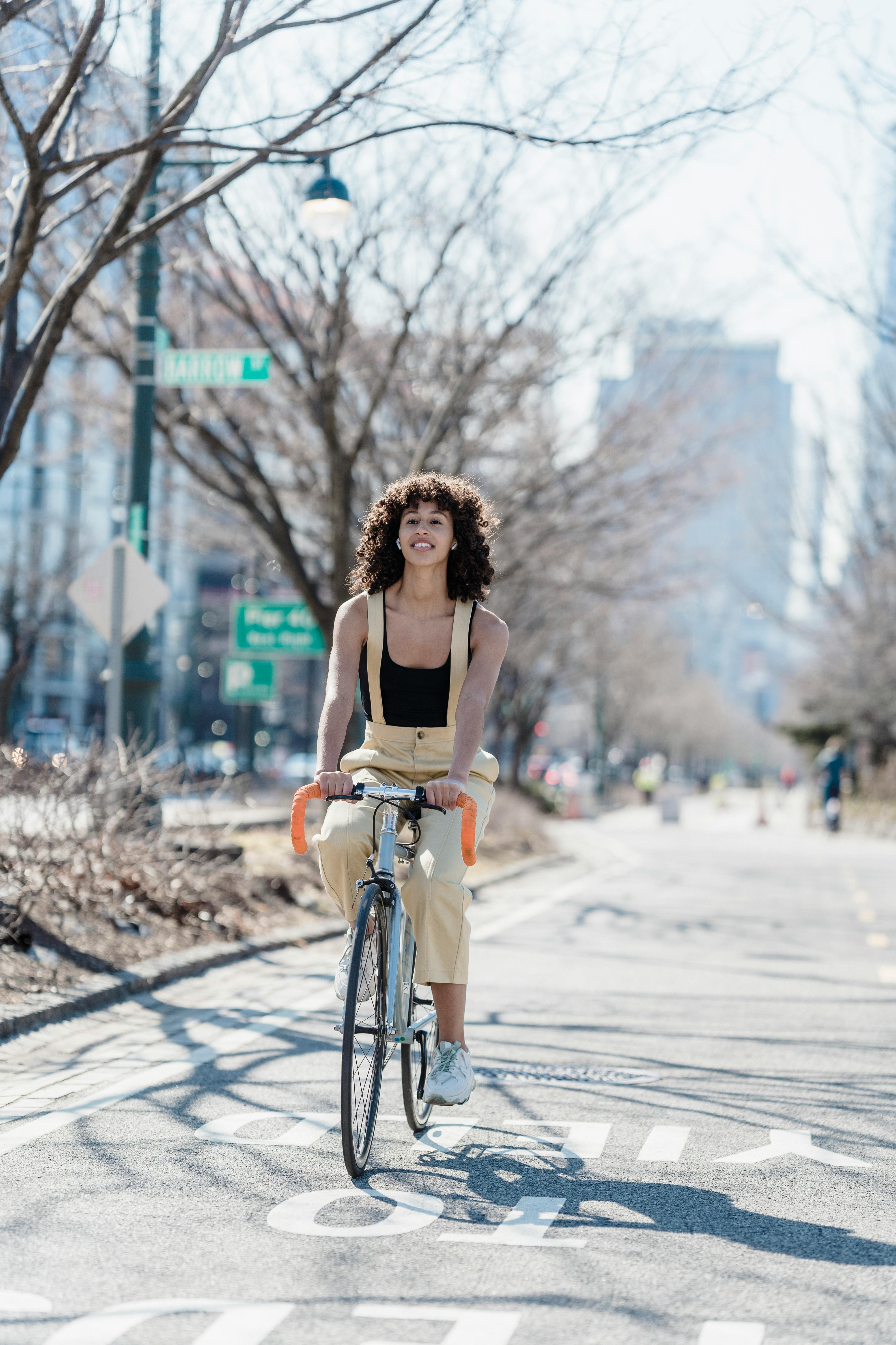 A Woman Riding a Road Bike · Free Stock Photo
