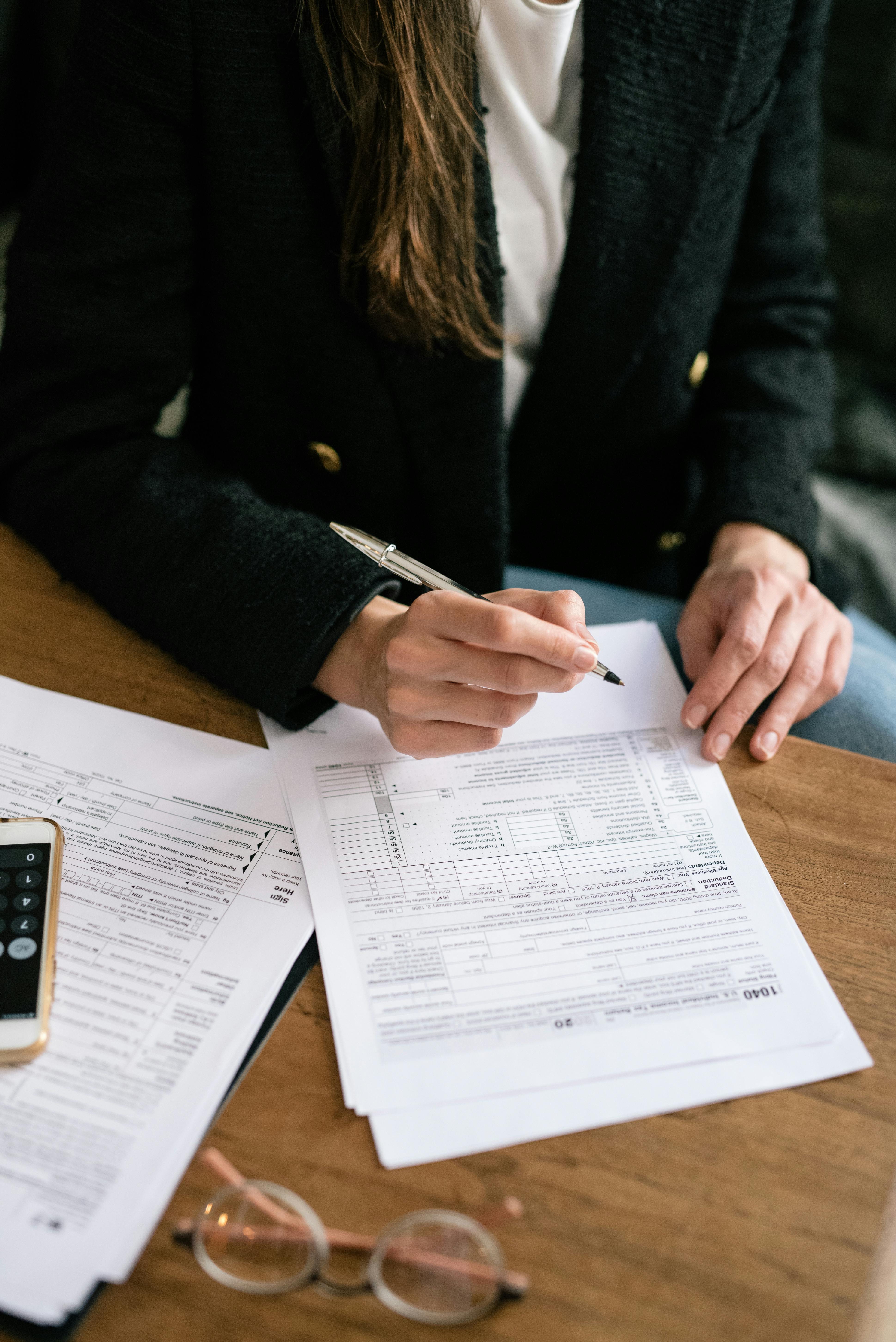 A Woman Writing on a Document · Free Stock Photo