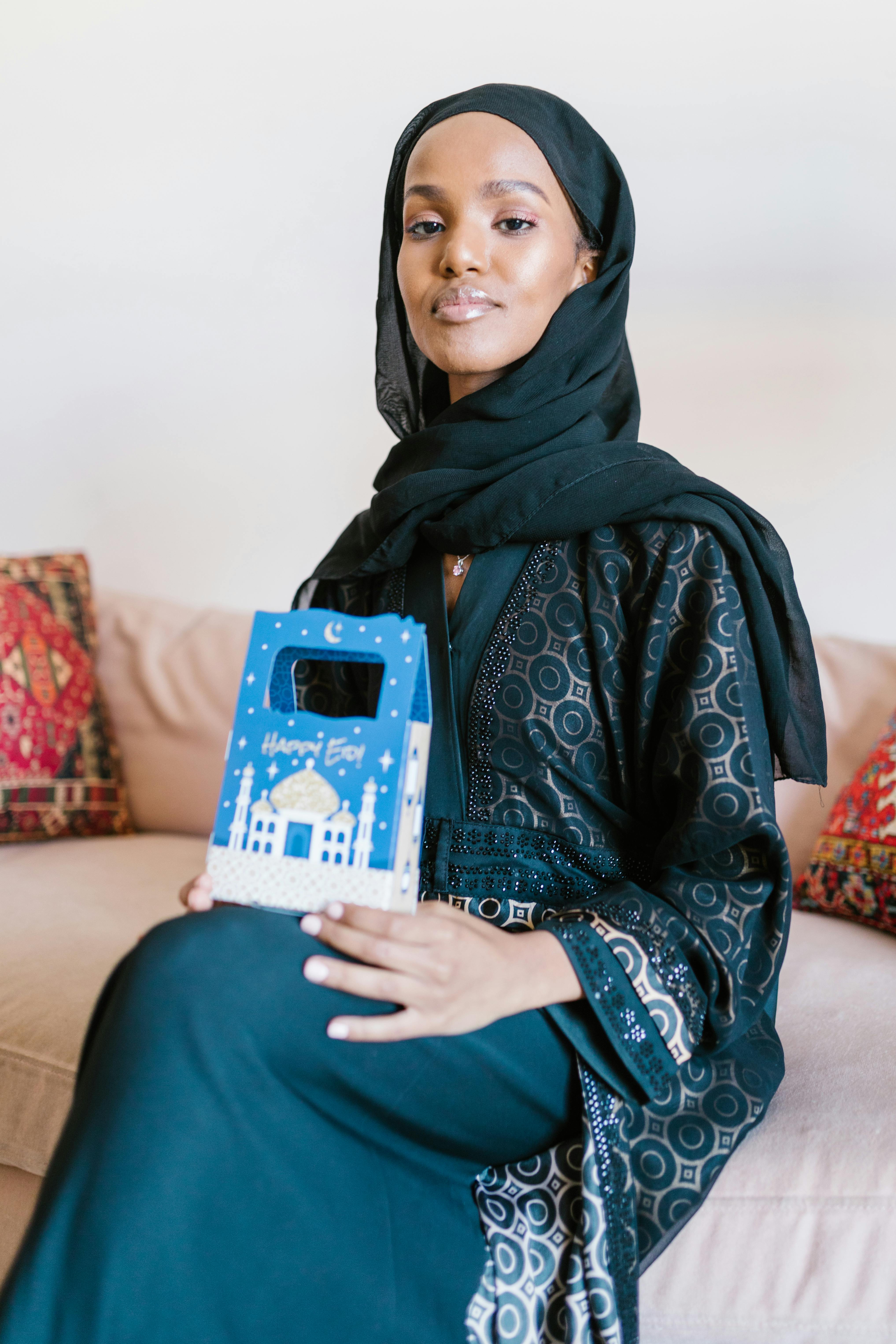 A Woman in Pink Hijab Packing the Items on the Table · Free Stock Photo
