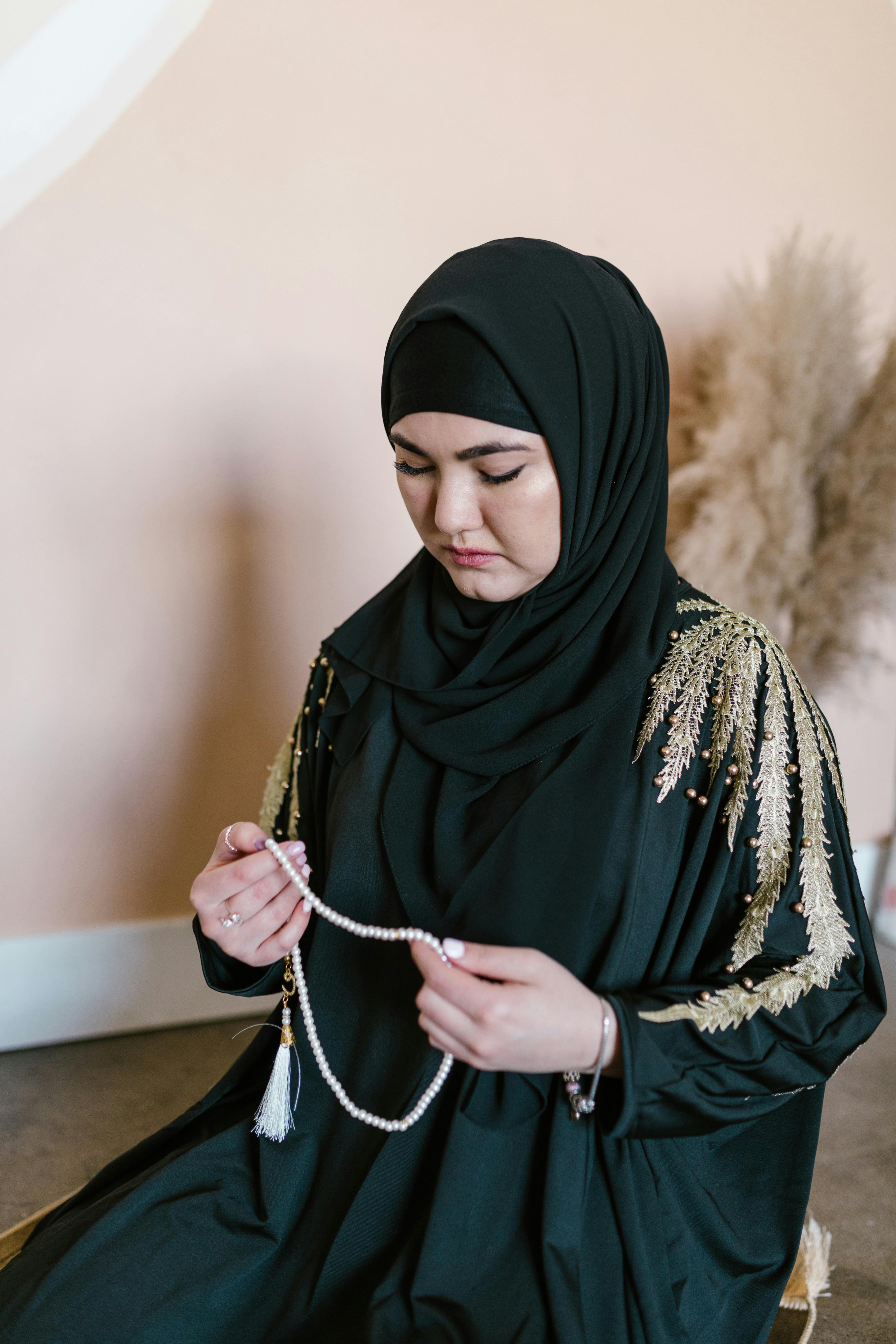 Woman in Hijab Sitting and Working on Sewing Machine · Free Stock Photo
