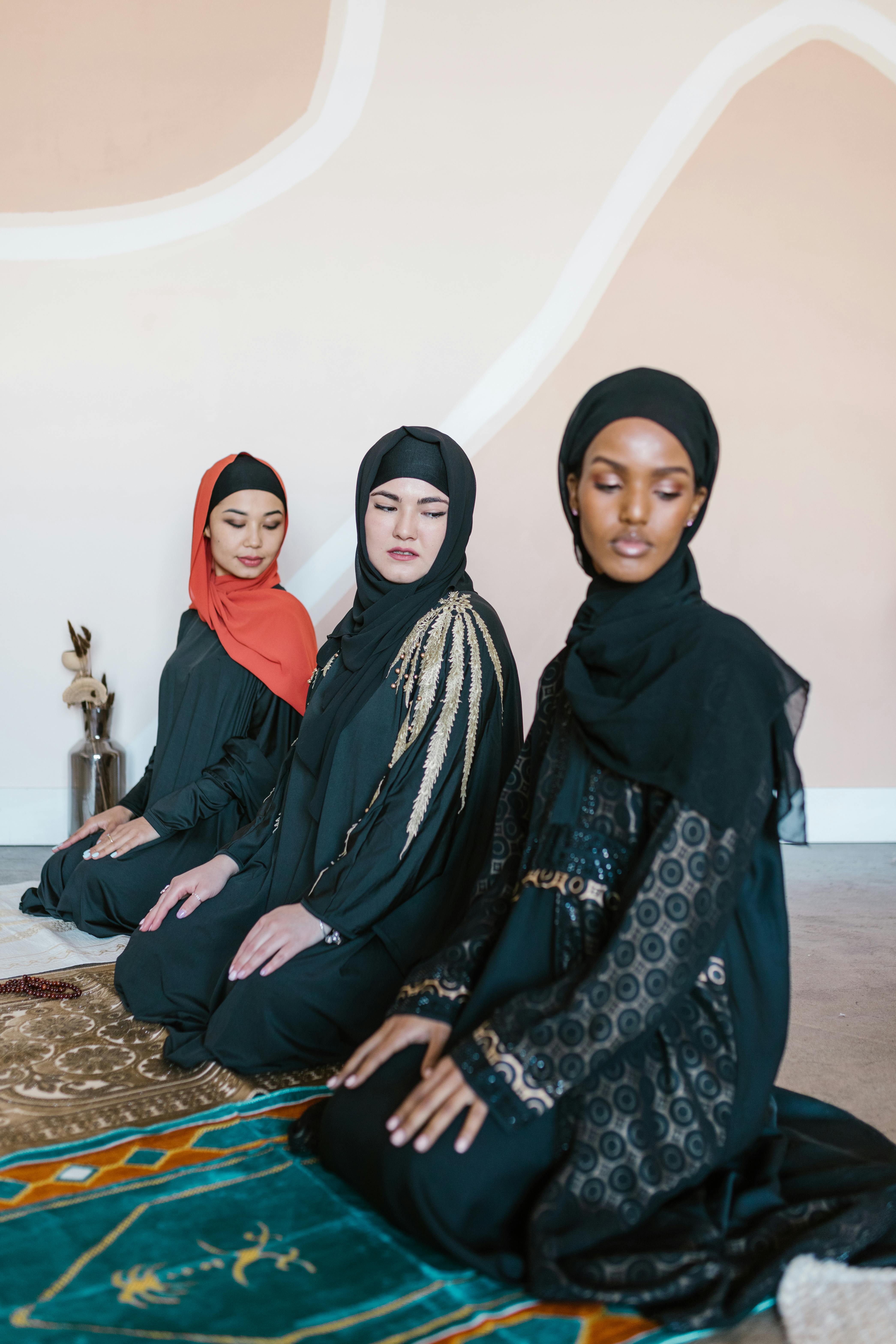 Women Wearing Hijabs Kneeling on Rugs · Free Stock Photo