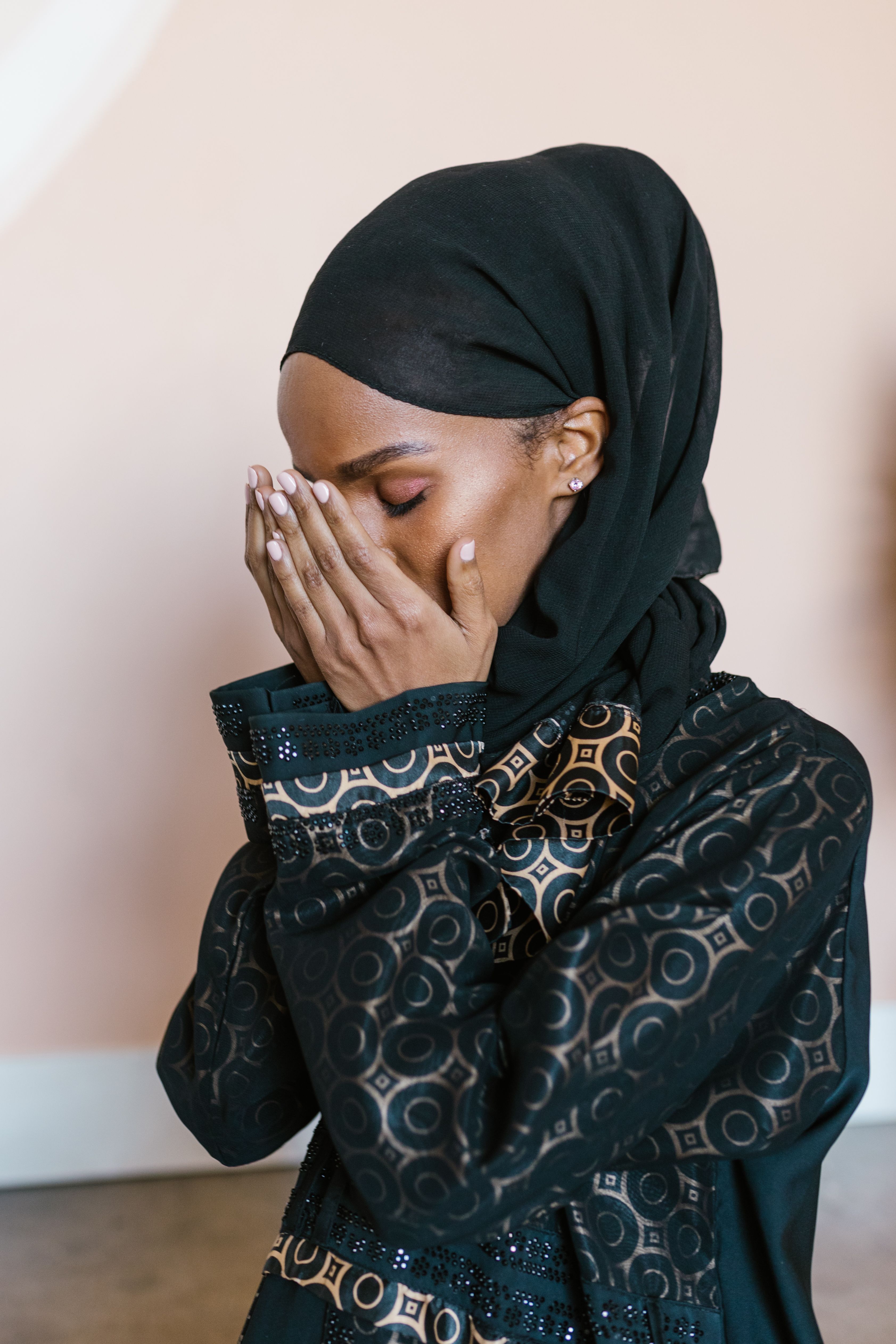 Woman in Black Hijab Covering Face With Hand · Free Stock Photo