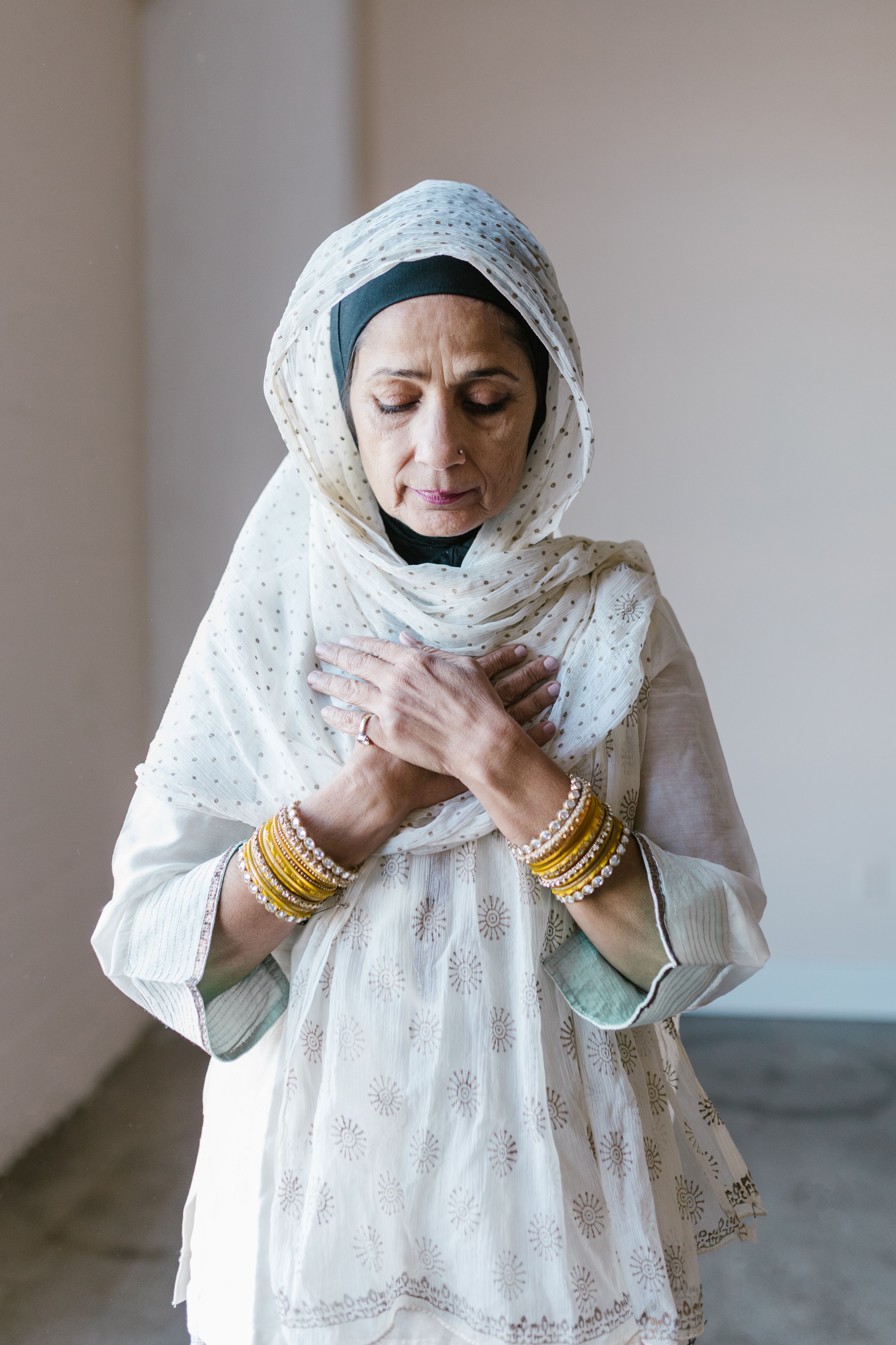 Woman in White Hijab and White Traditional Dress Praying · Free Stock Photo