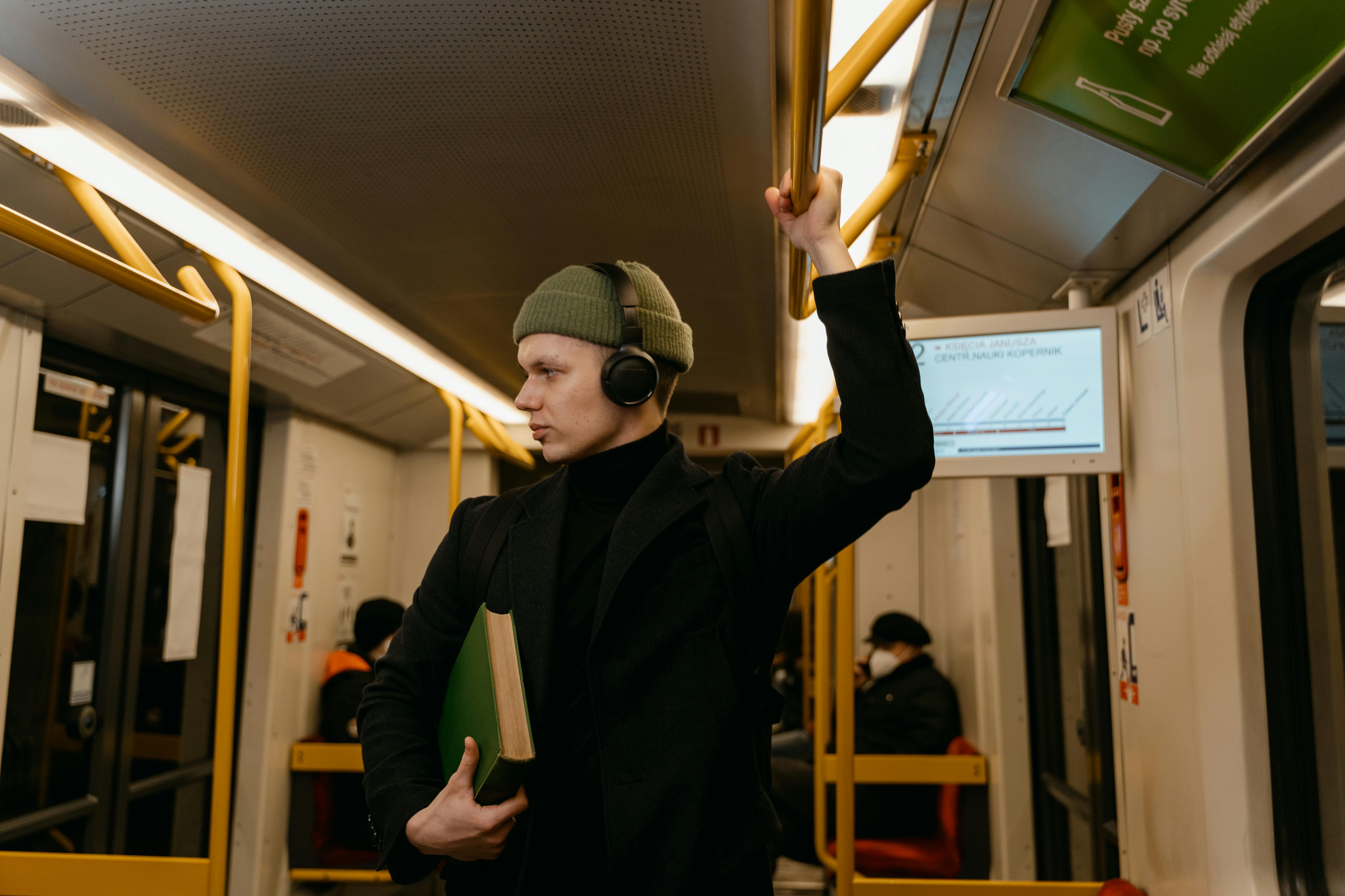 A Man Listening to Music while Riding a Train · Free Stock Photo