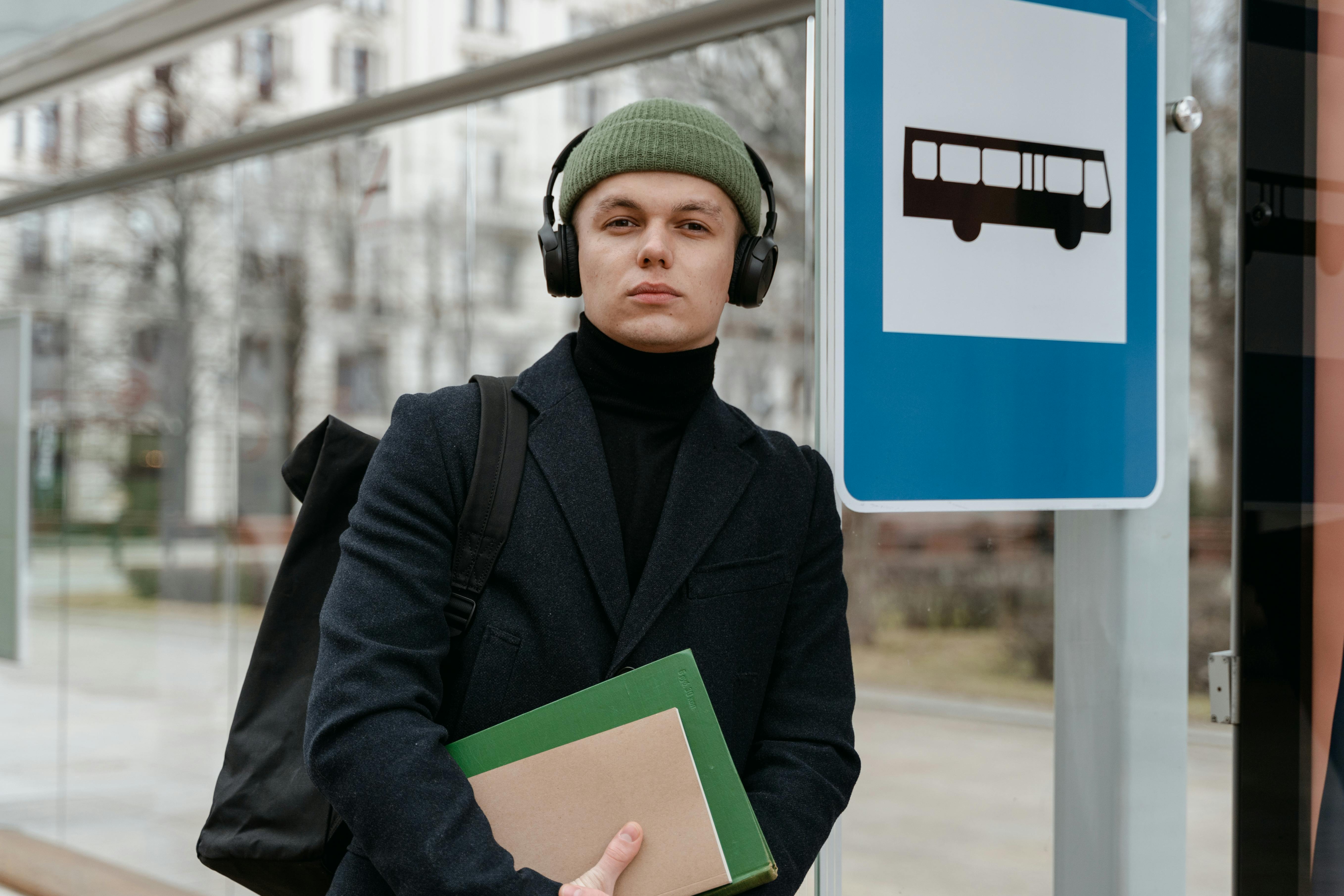 A Man Standing Near a Bus Stop · Free Stock Photo